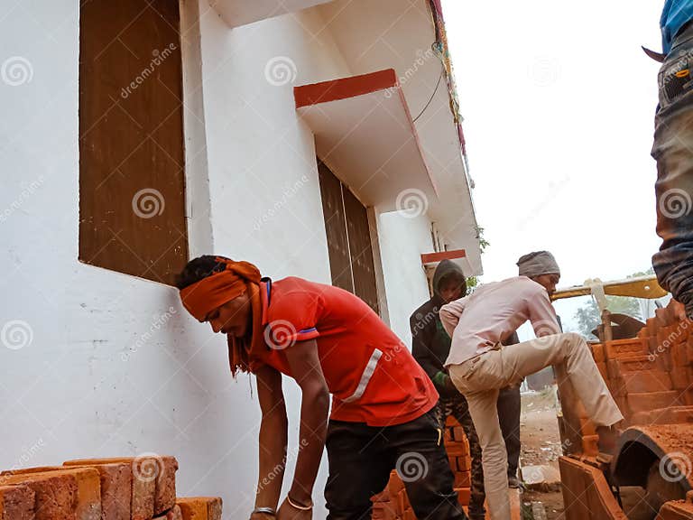 Indian Construction Workers Unloading Bricks from Tractor at Site in ...
