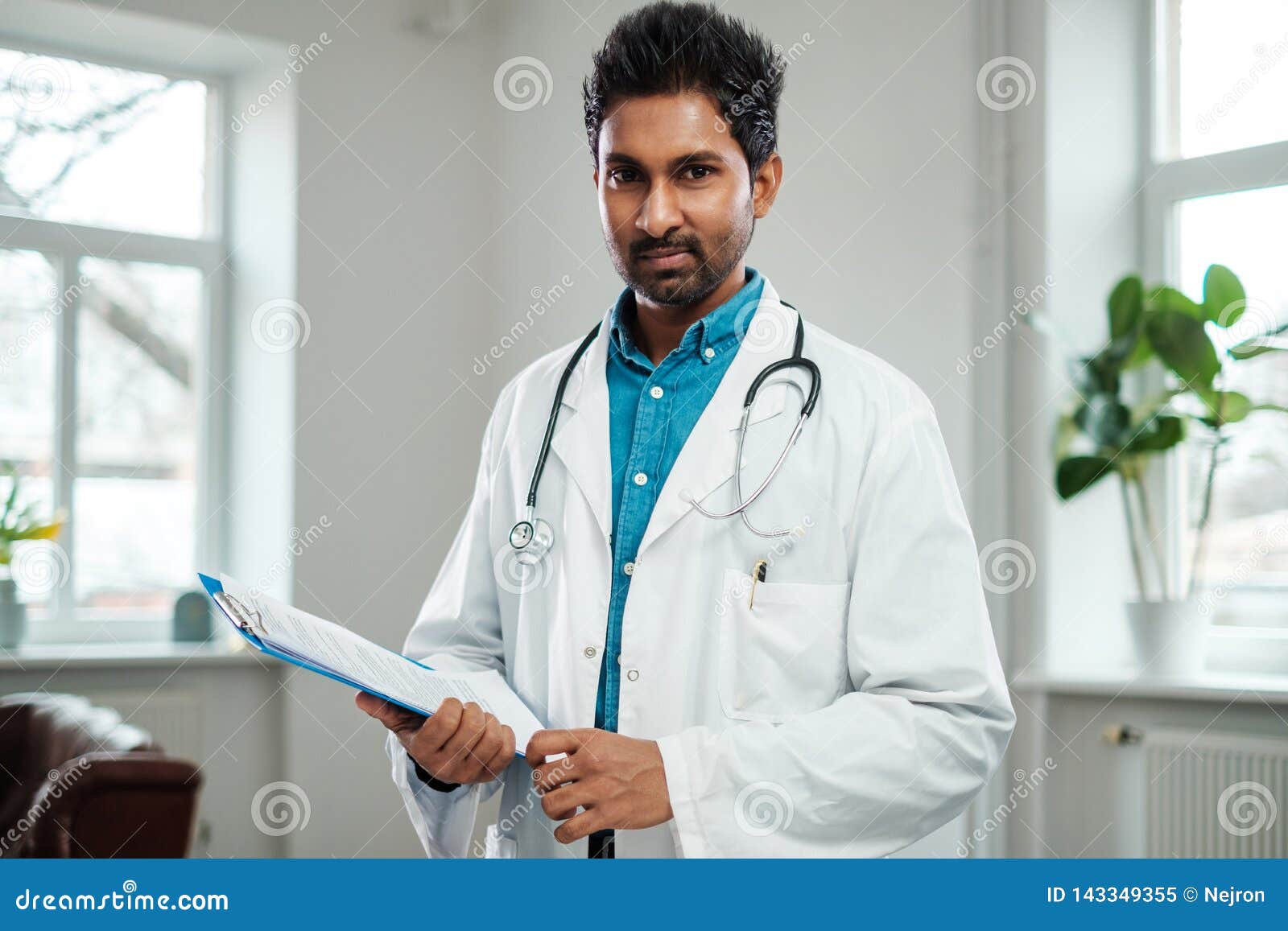 Indian Doctor with Stethoscope Around Neck in His Office Stock Image ...