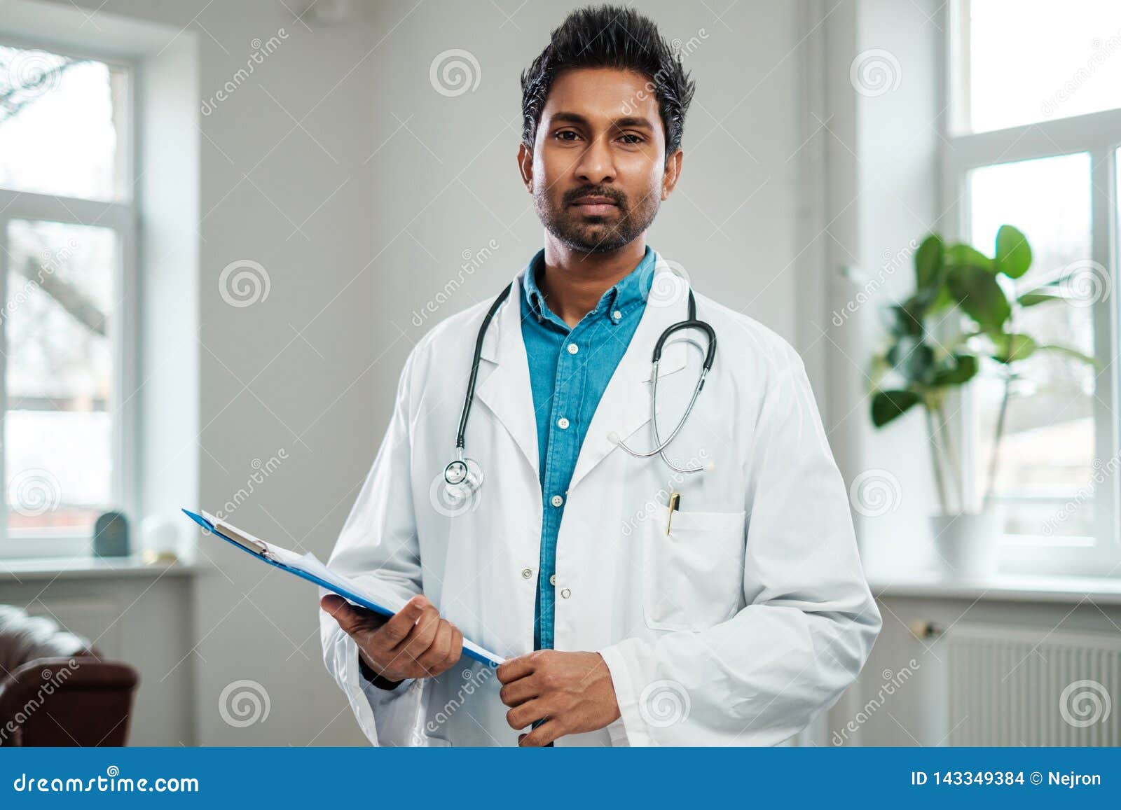 Indian Doctor with Stethoscope Around Neck in His Office Stock Photo ...