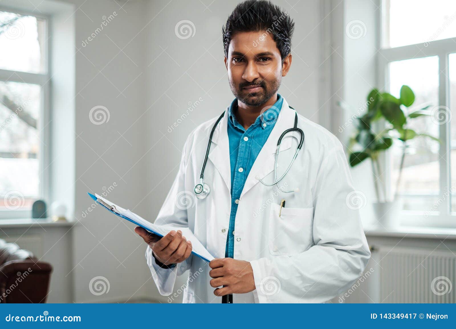 Indian Doctor with Stethoscope Around Neck in His Office Stock Image ...