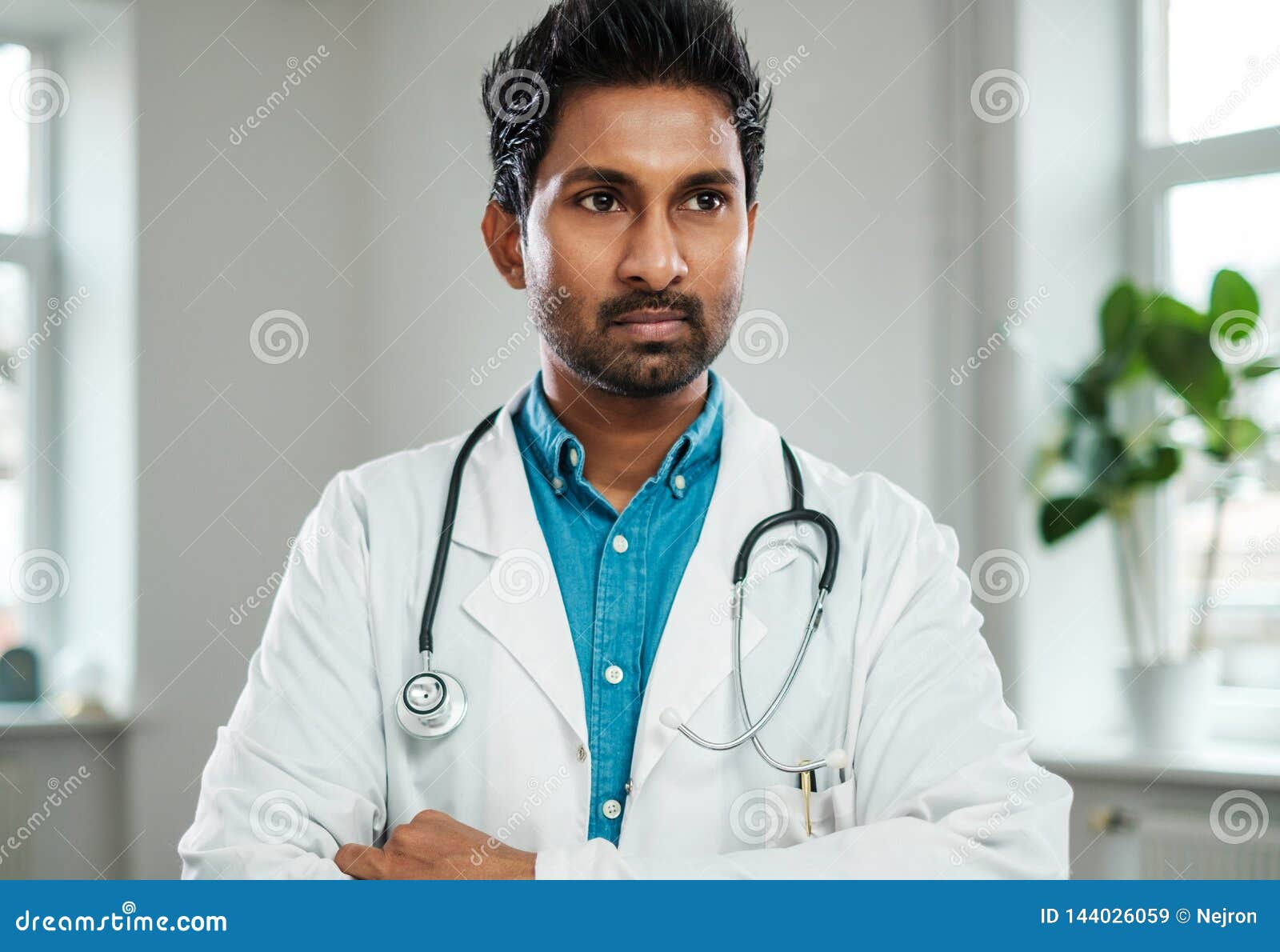 Indian Doctor with Stethoscope Around Neck in His Office Stock Image ...