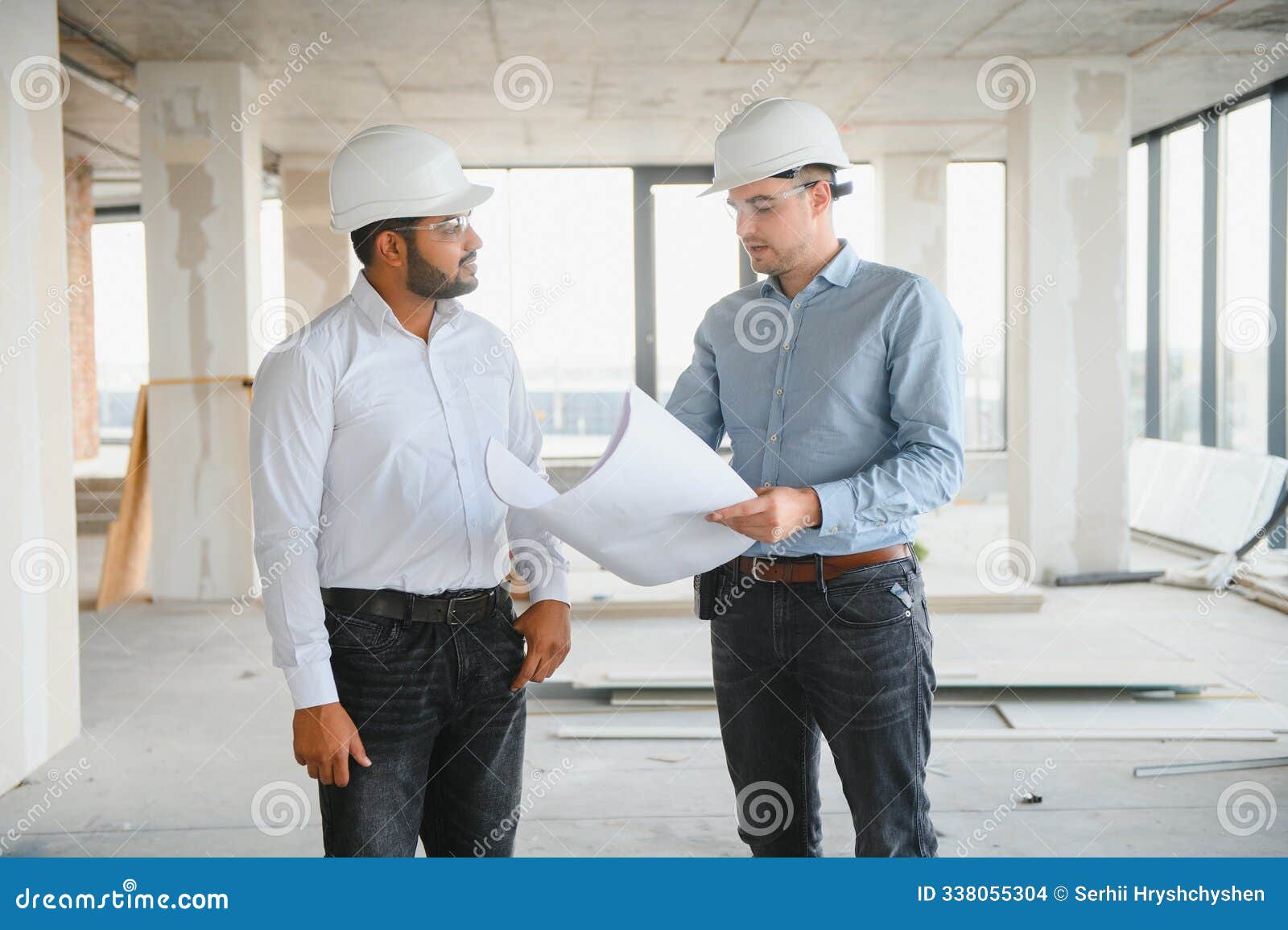 Indian and European Construction Workers Together at a Construction ...