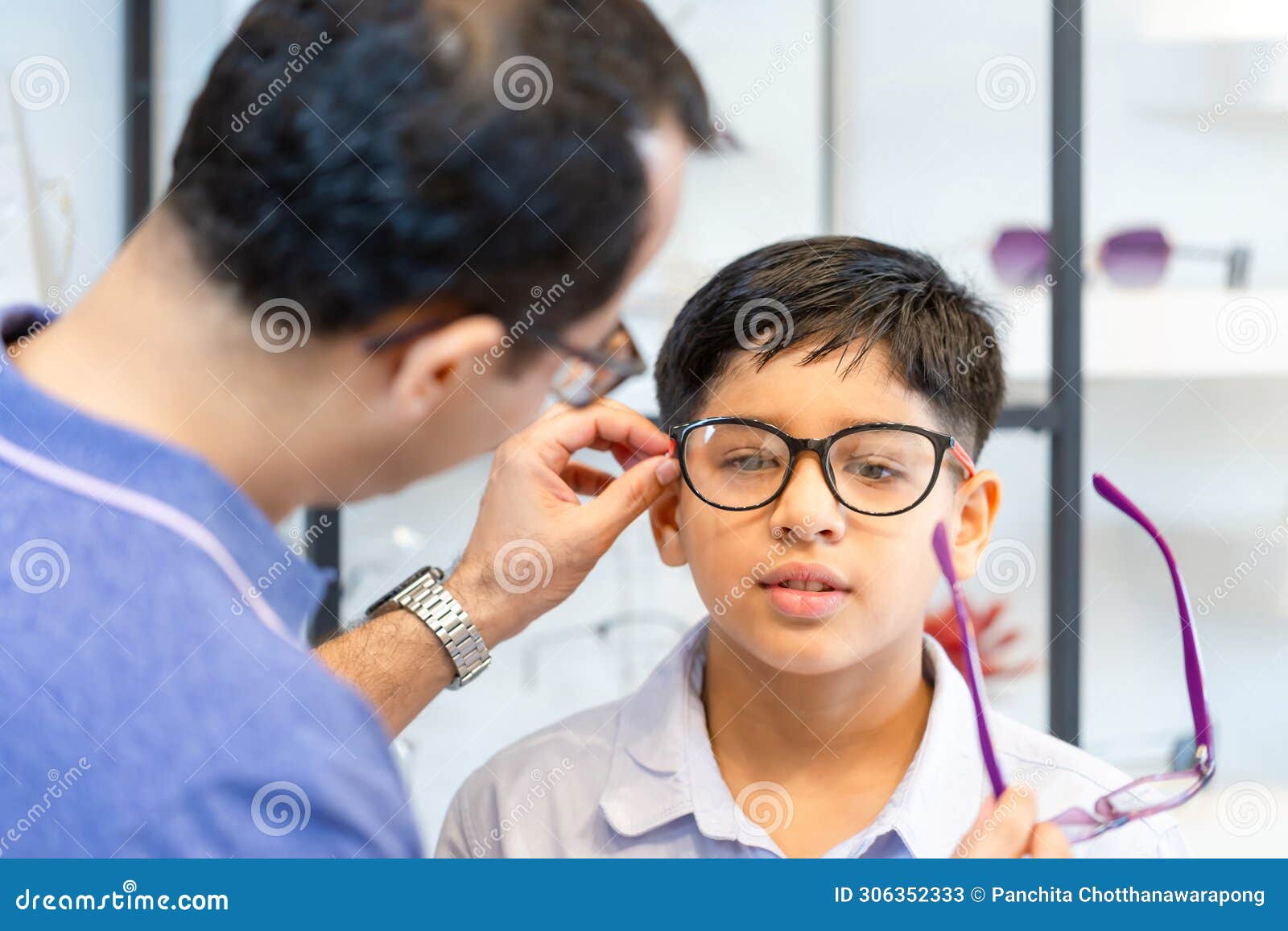 Indian Father and Son Choosing Eyeglasses in Optics Store Stock Image - Image of optics, care ...
