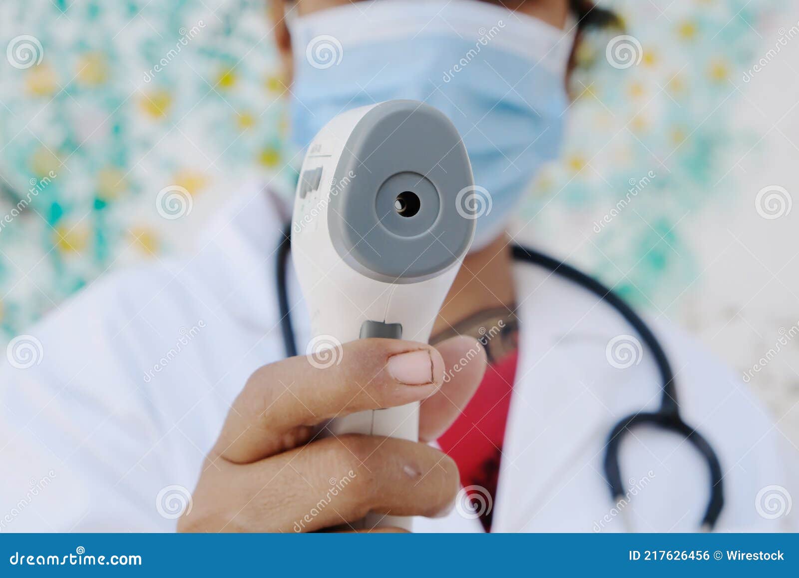 Indian Female Doctor Using an Electronic Thermometer Stock Photo ...
