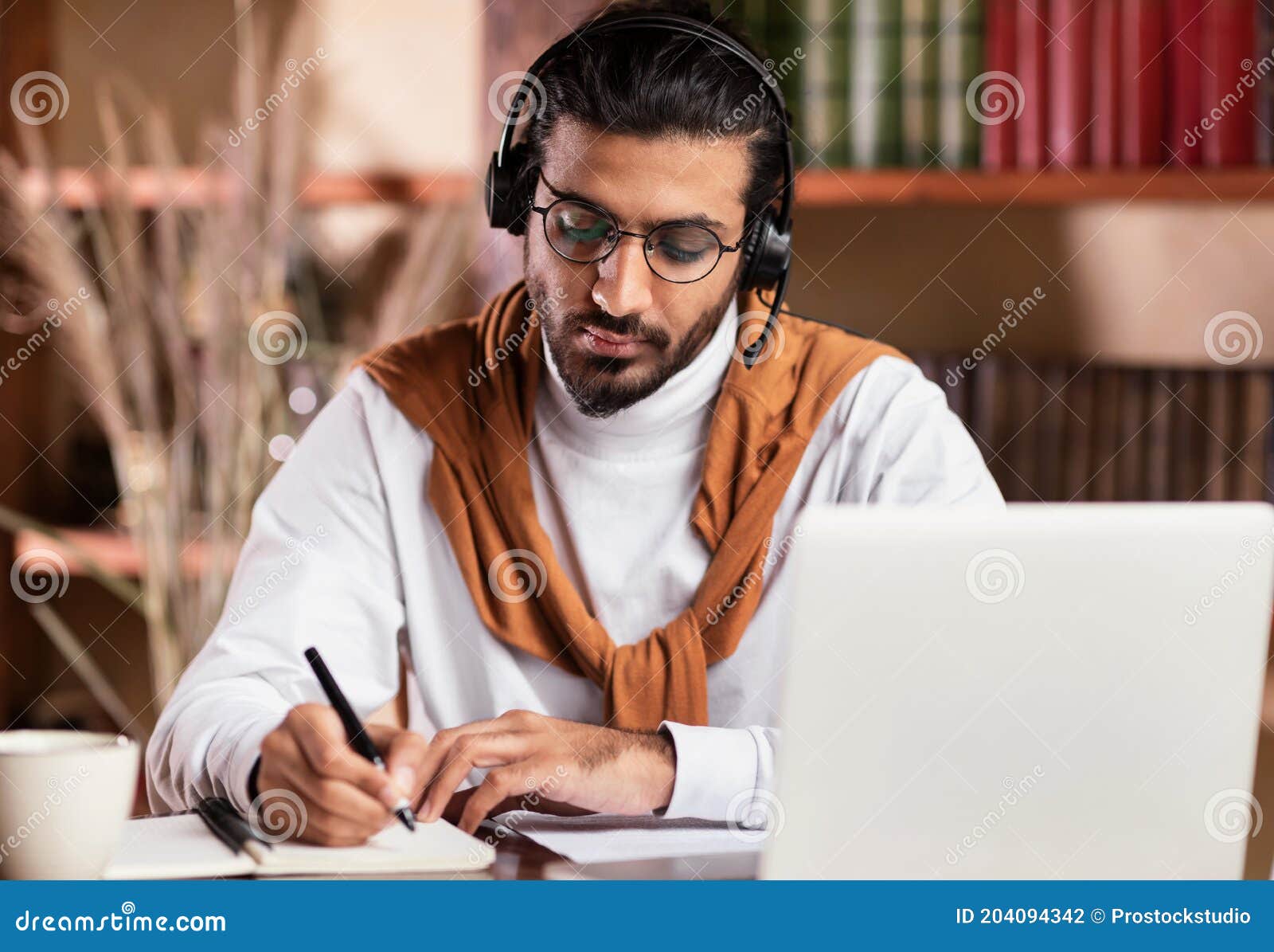 Indian Guy Taking Notes Learning at Laptop Online at Home Stock Photo ...