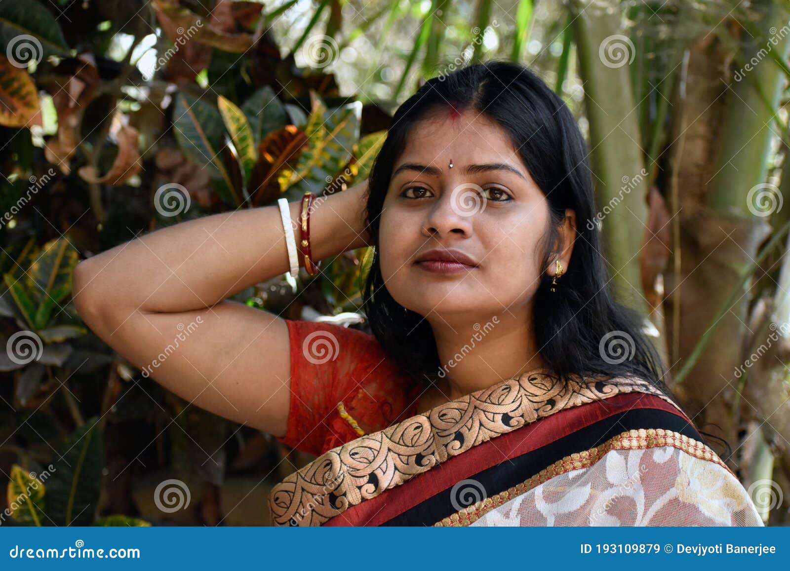 The Indian Housewife In The Casual Clothing On A Forest Background