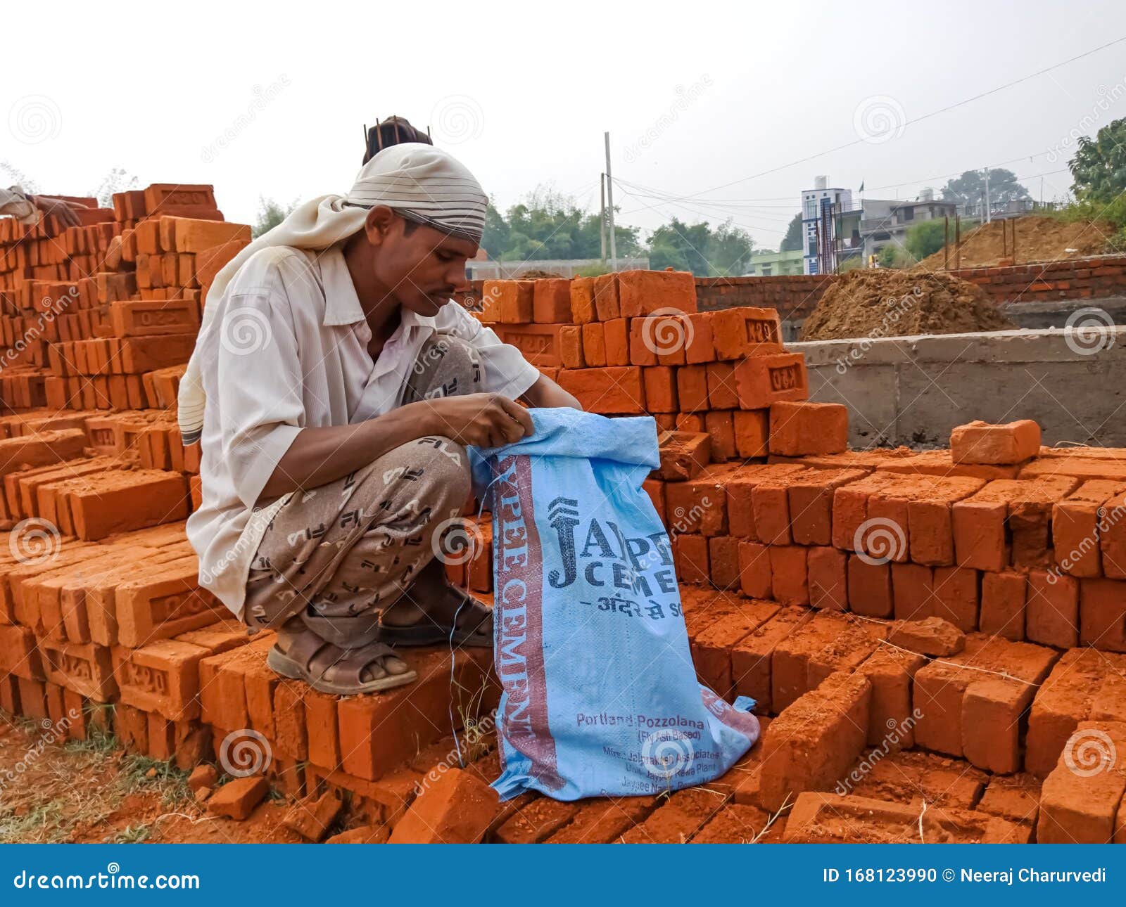 An Indian Labour Putting Bricks Inside Tha Sack at Construction Site in ...