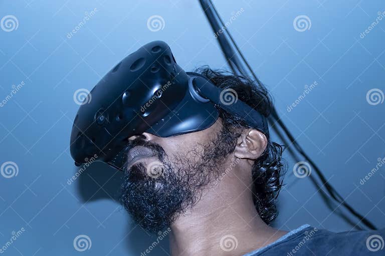 Indian Looking Man Using VR Technology on Blue Light Stock Image ...