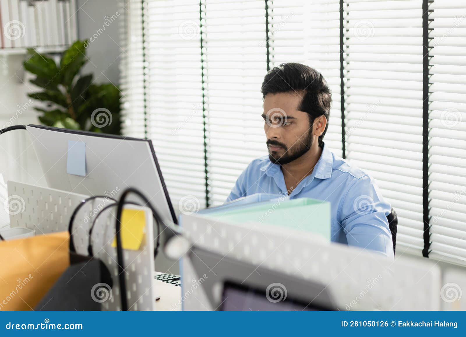 Indian Male Office Worker, Working on Analyzing Statistics Charts ...