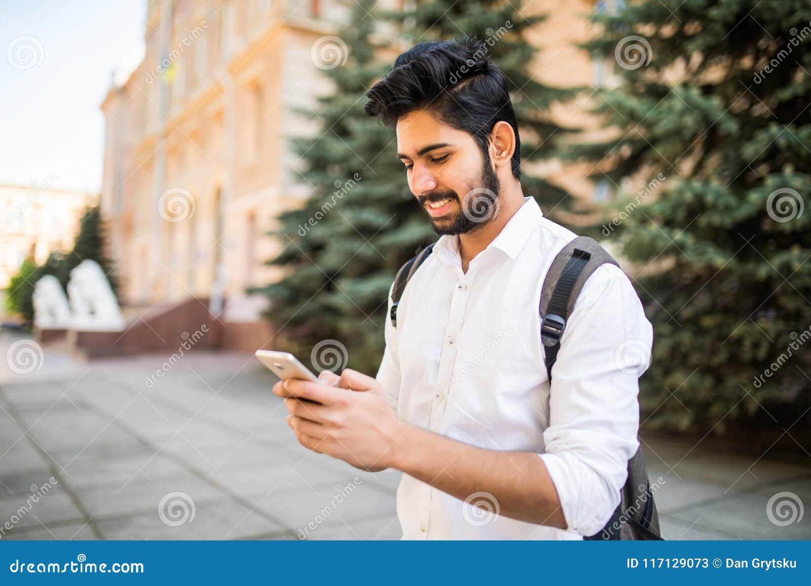 Handsome Young Indian Male Student Texting on Smartphone in the Street ... Handsome Young Indian Male Student Texting on Smartphone in the Street ...