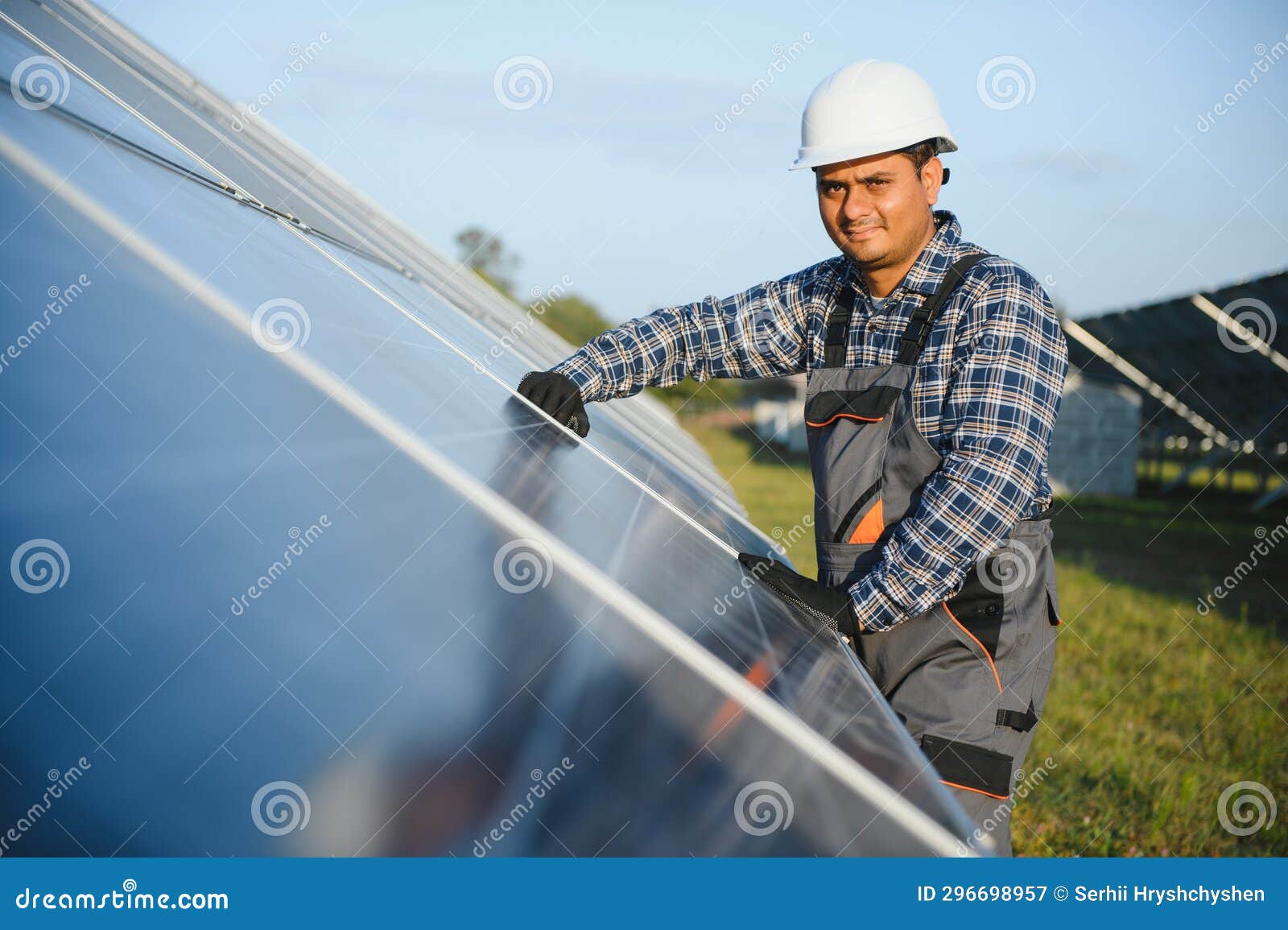 An Indian Male Worker is Working on Installing Solar Panels in a Field ...