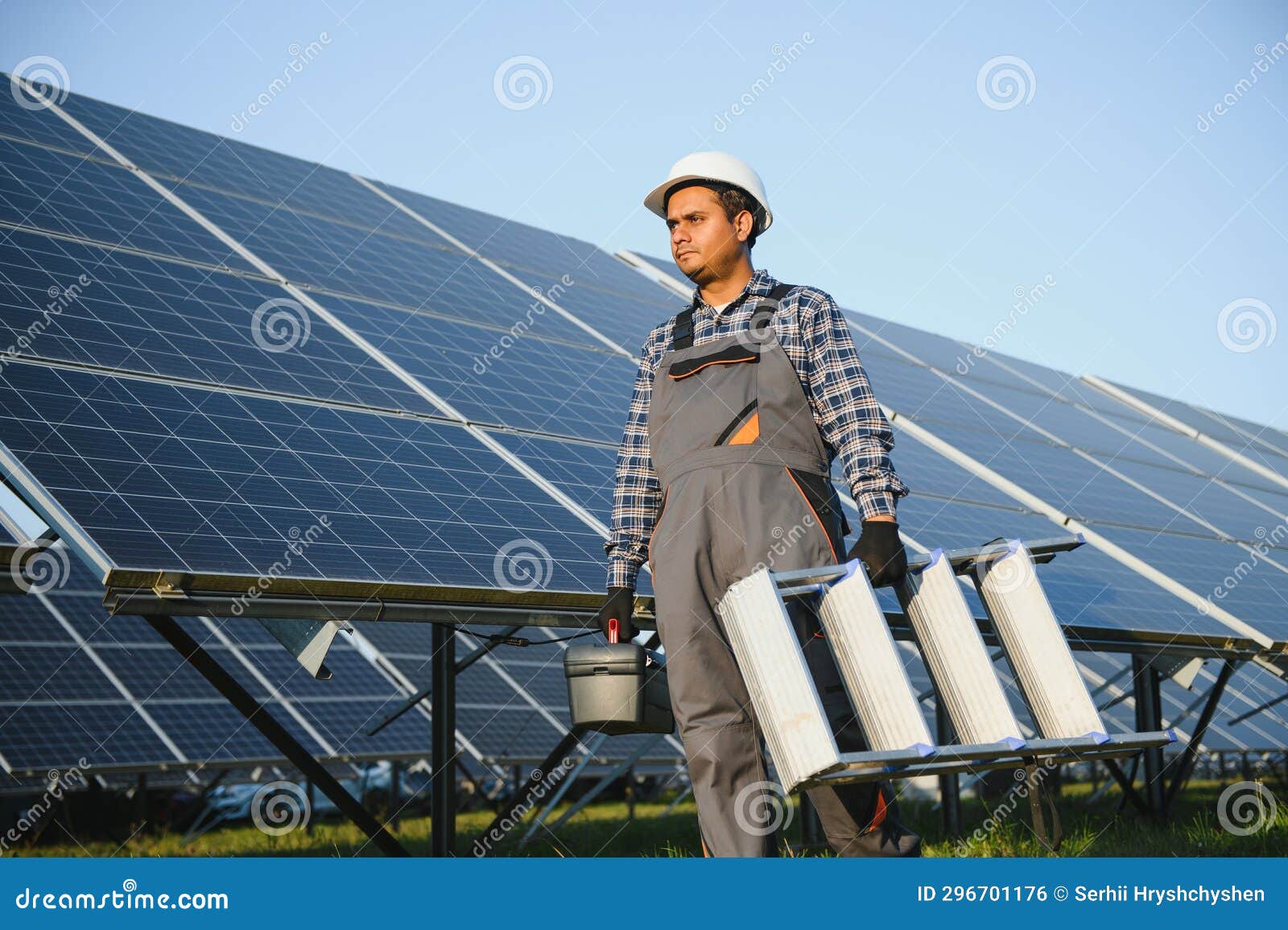 An Indian Male Worker is Working on Installing Solar Panels in a Field ...