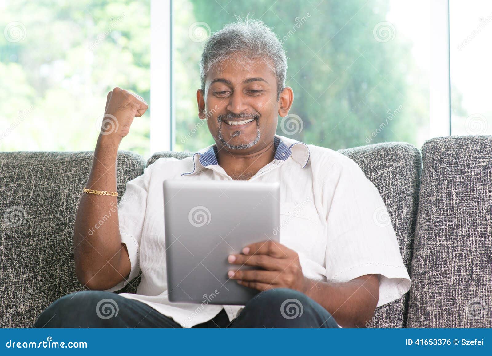 Indian Man Cheering while Using Tablet Pc Stock Photo - Image of ...