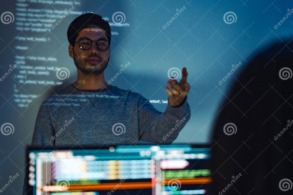 Indian Man Programmer Standing in Front of a Screen with Code Projected ...