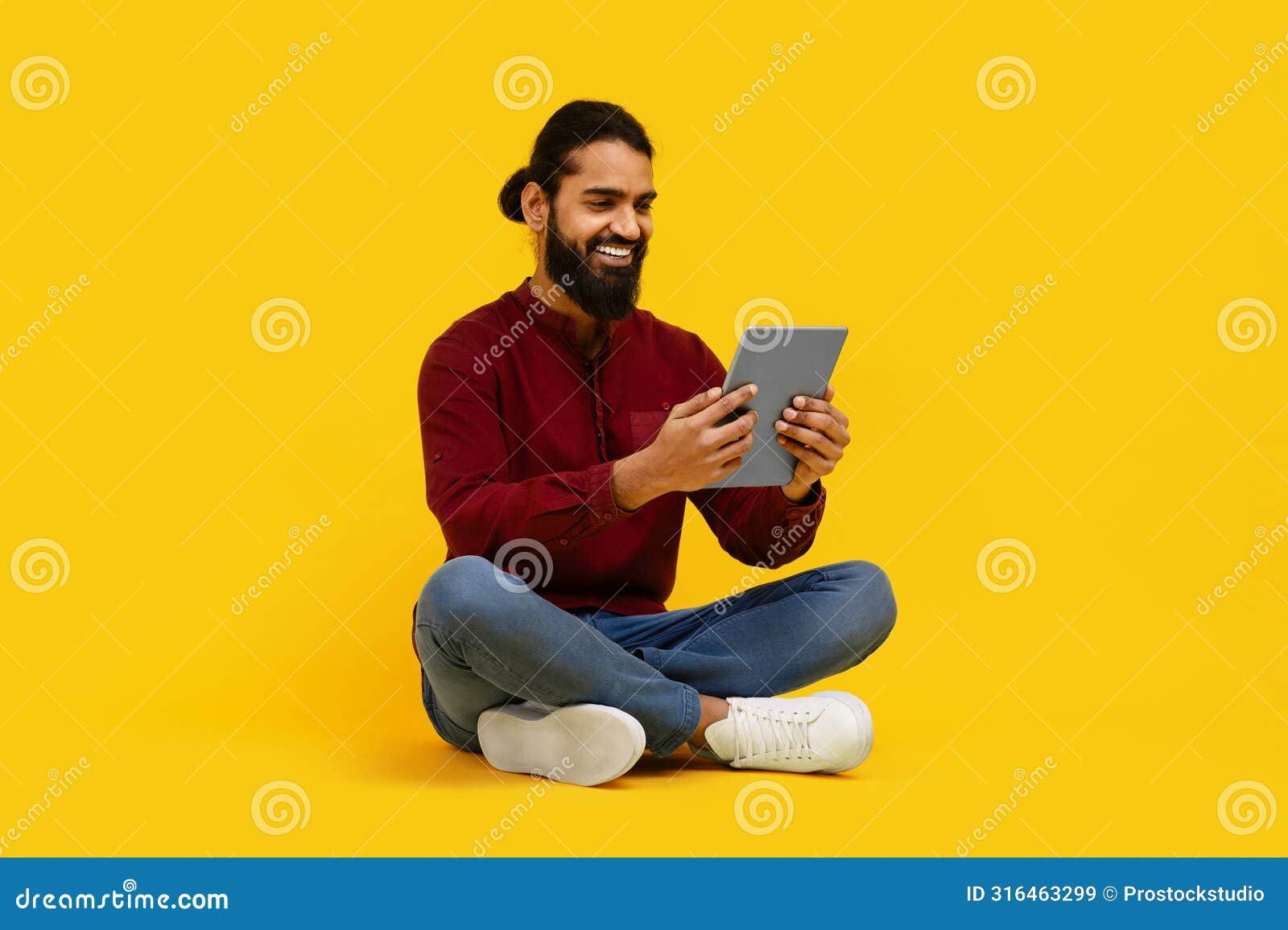 Indian Man Sitting on Floor Using Tablet Stock Image - Image of ...