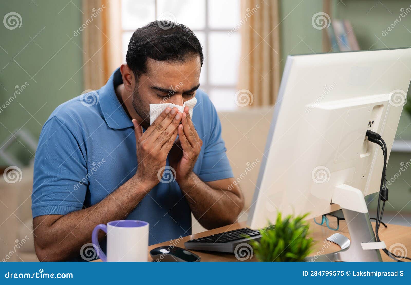 Indian Man Suffering from Cold Sneezing while Working on Computer at ...