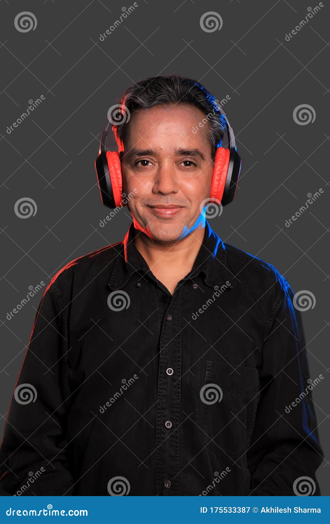 Indian Man with Wireless Bluetooth Headphones on Grey Background Stock ...