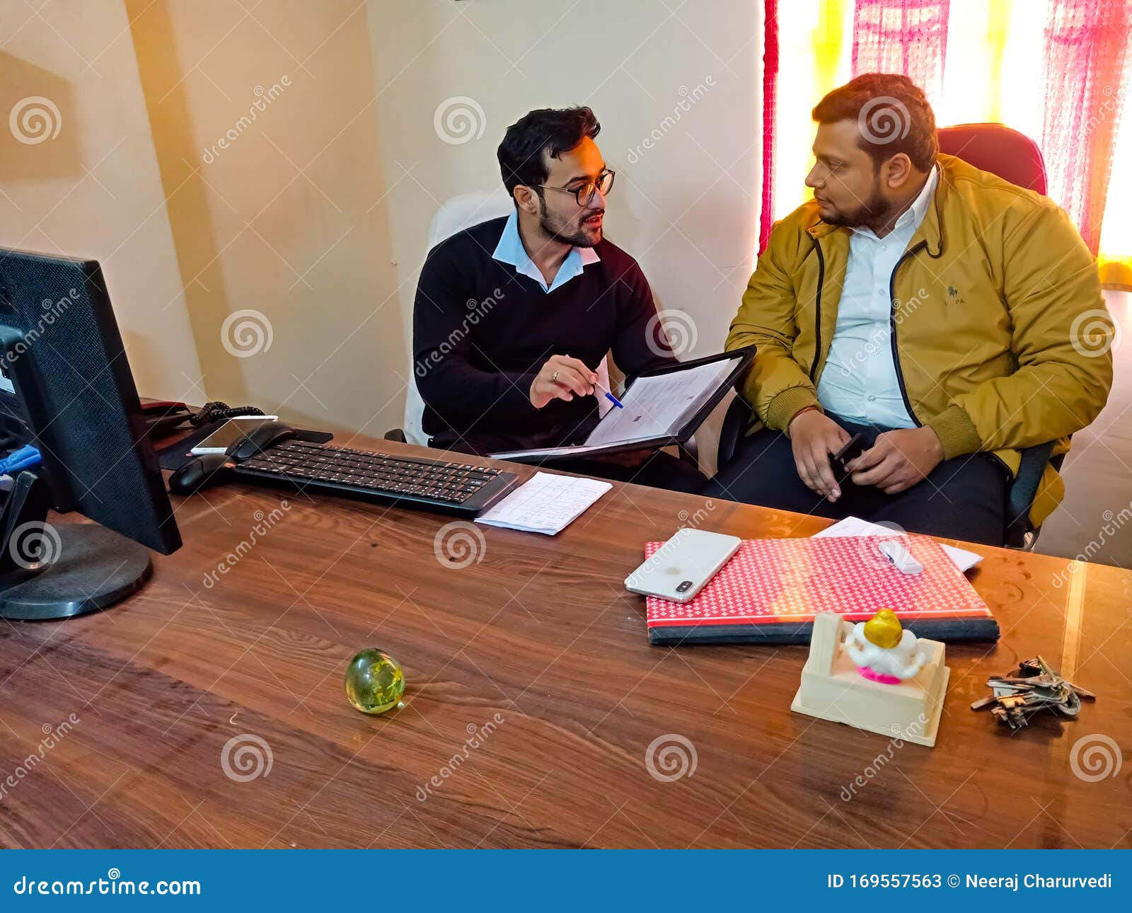 An Indian Office Manager Verifying Document during Work in India ...