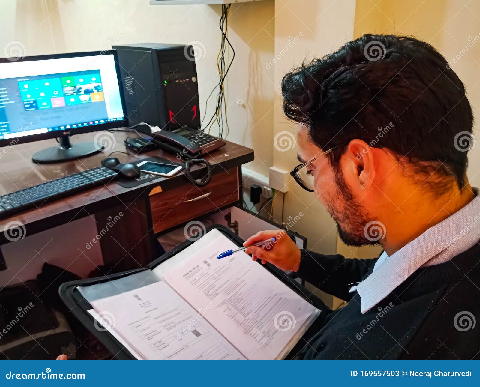 An Indian Office Staff Man Verifying Document during Work in India ...