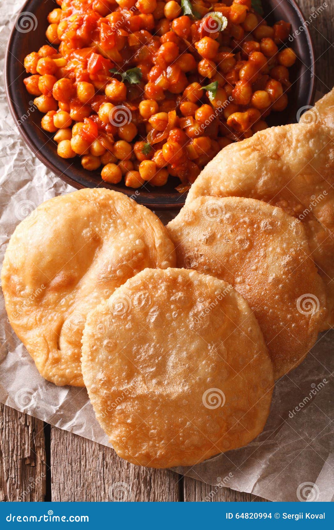 Indian Puri and Chana Masala Close-up on the Table. Vertical Top Stock ...