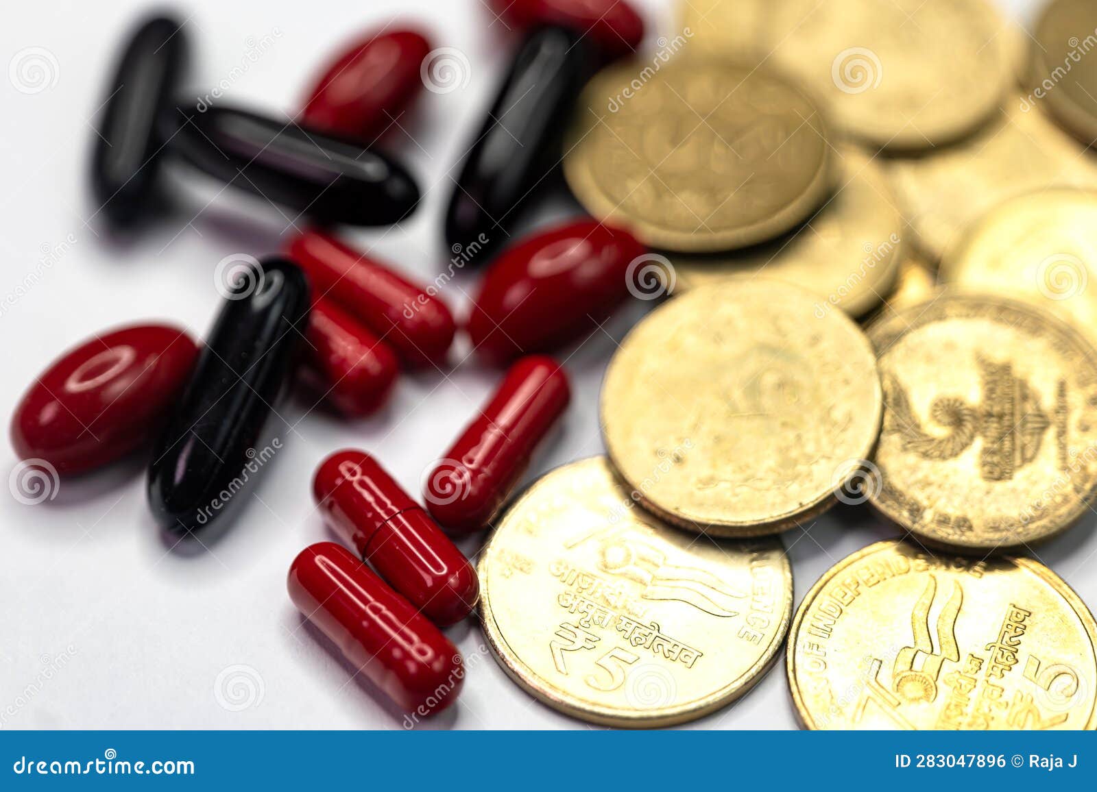Indian 5 Rupees Coins and Red and Black Pills on White Backdrop Stock ...