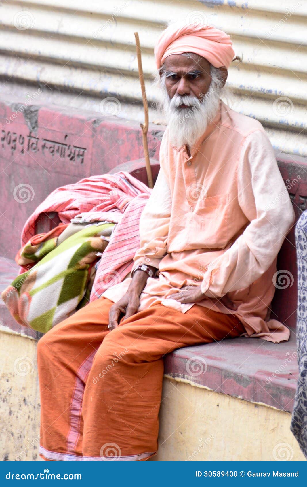 A Aged Sadhu Getting Down The Steps With A Stick In His Hand At ...