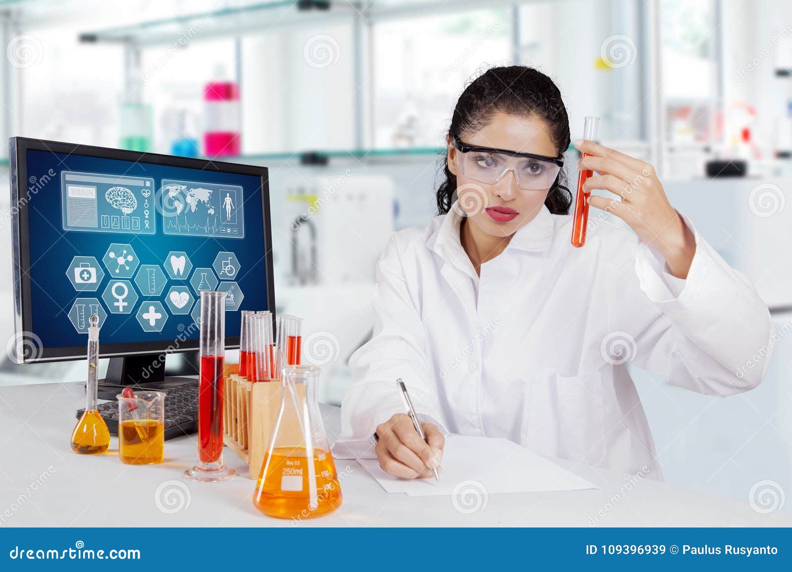 Indian Scientist Working with a Computer and Doing Chemical Test Stock ...