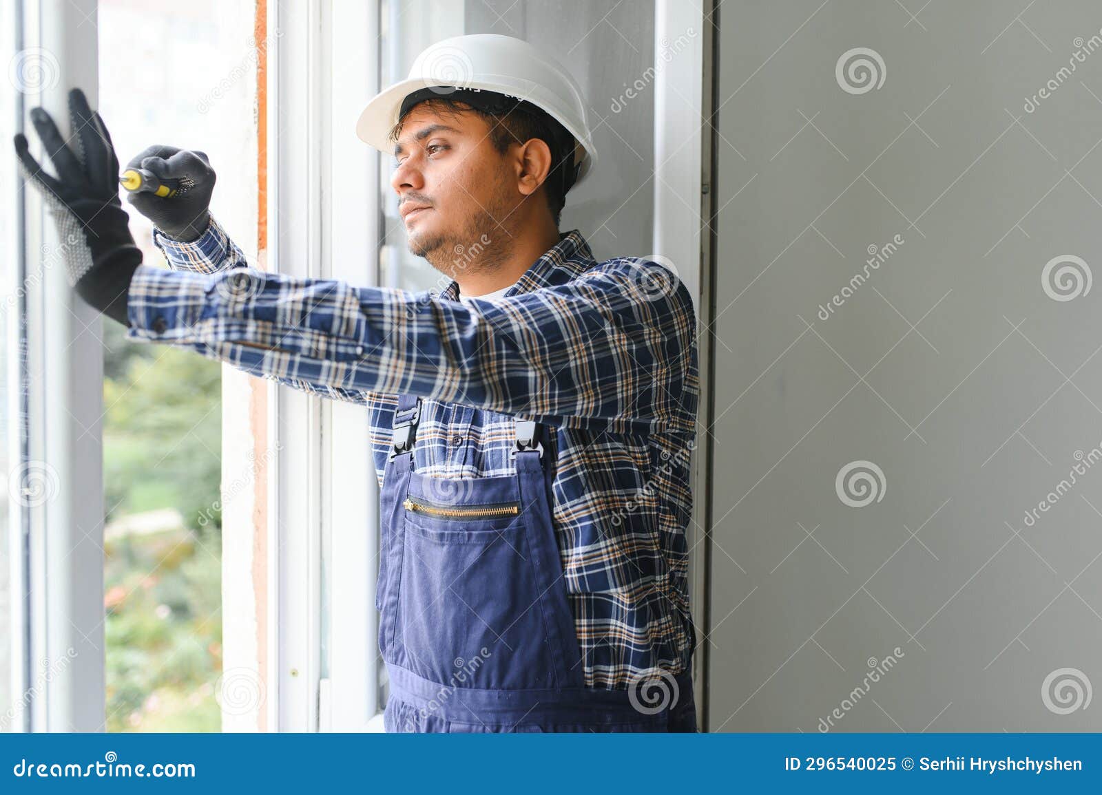 Indian Service Man Installing Window with Screwdriver Stock Image ...