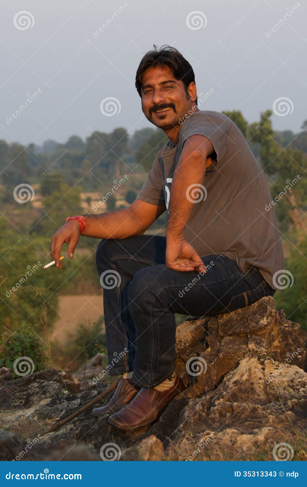 Indian smoking and smiling stock image. Image of sitting - 35313343