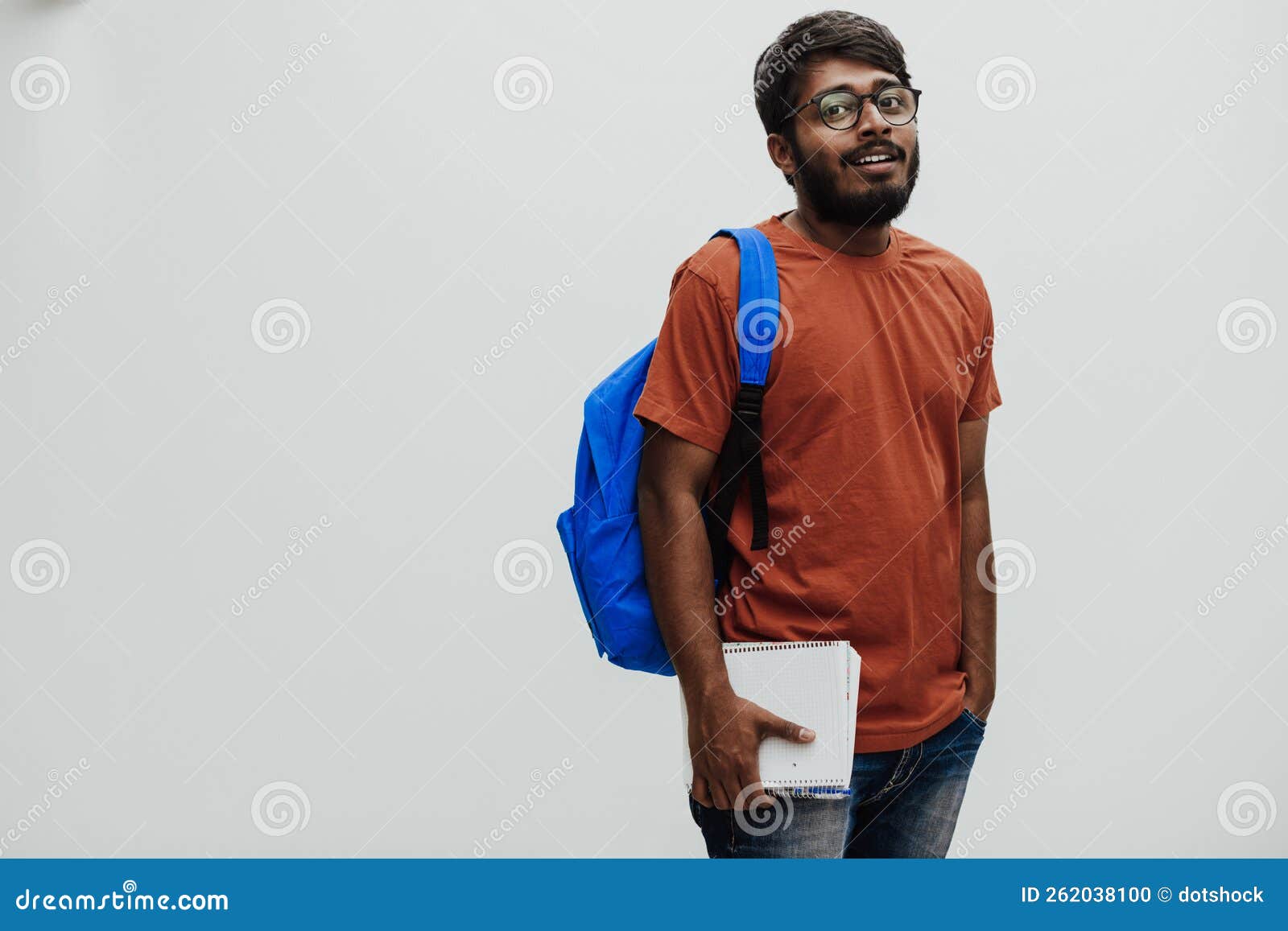 Indian Student with Blue Backpack, Glasses and Notebook Posing on Gray ...