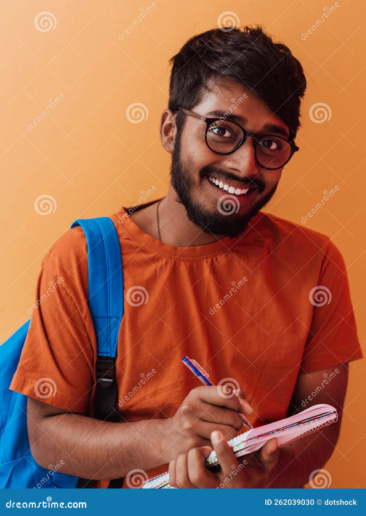 Indian Student with Blue Backpack, Glasses and Notebook Posing on ...
