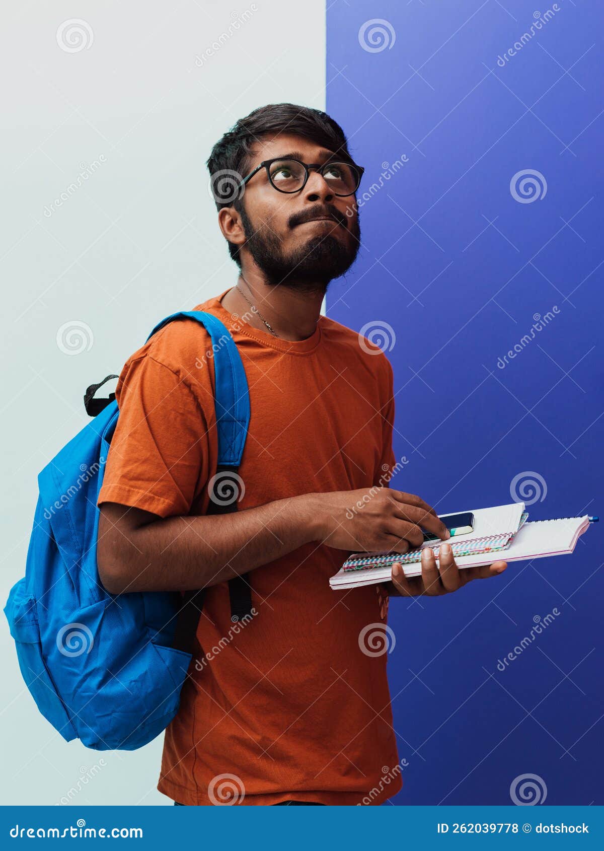 Indian Student with Blue Backpack, Glasses and Notebook Posing on the ...