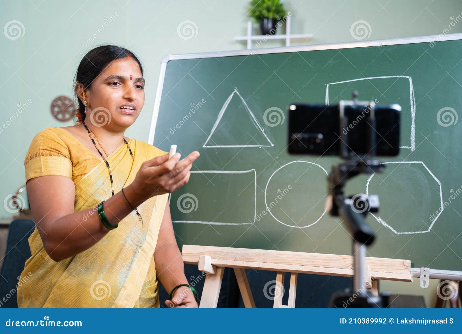 Indian Woman Explaining To Students from Board during Online Class in ...