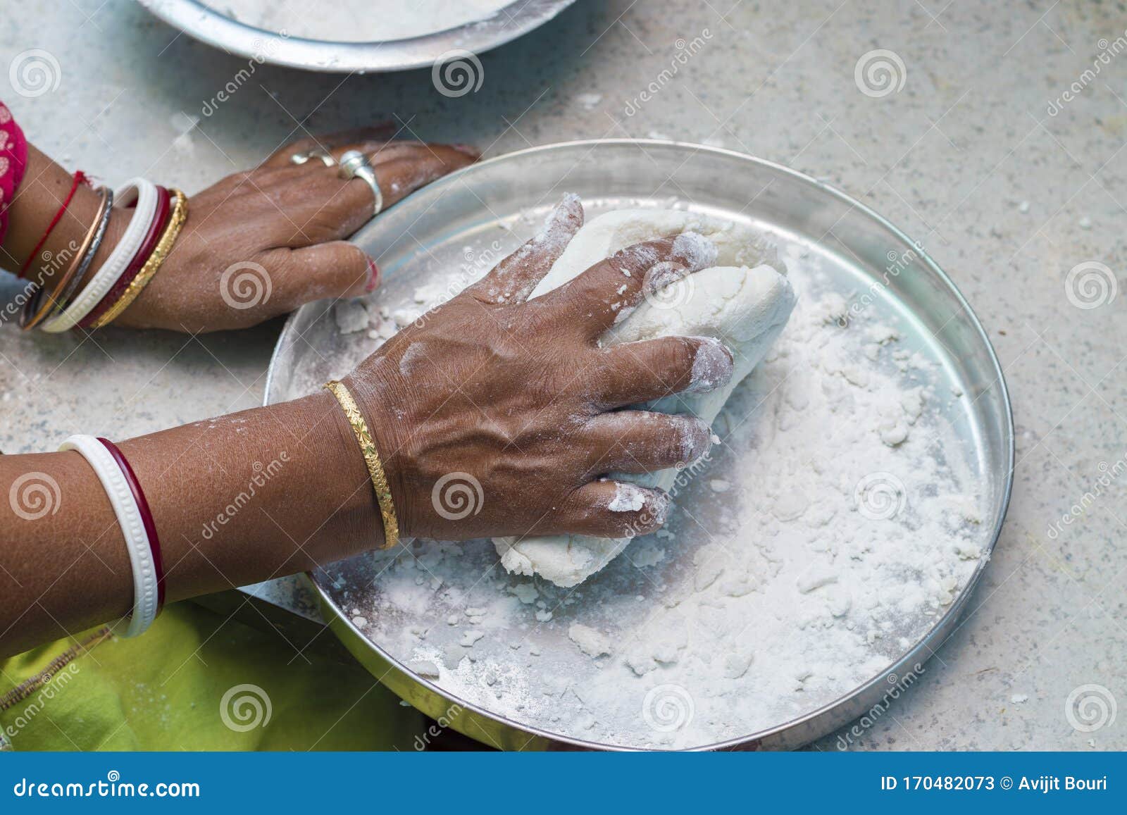 An Indian Woman Scooping Flour/rice Powder for Making Breads Stock ...