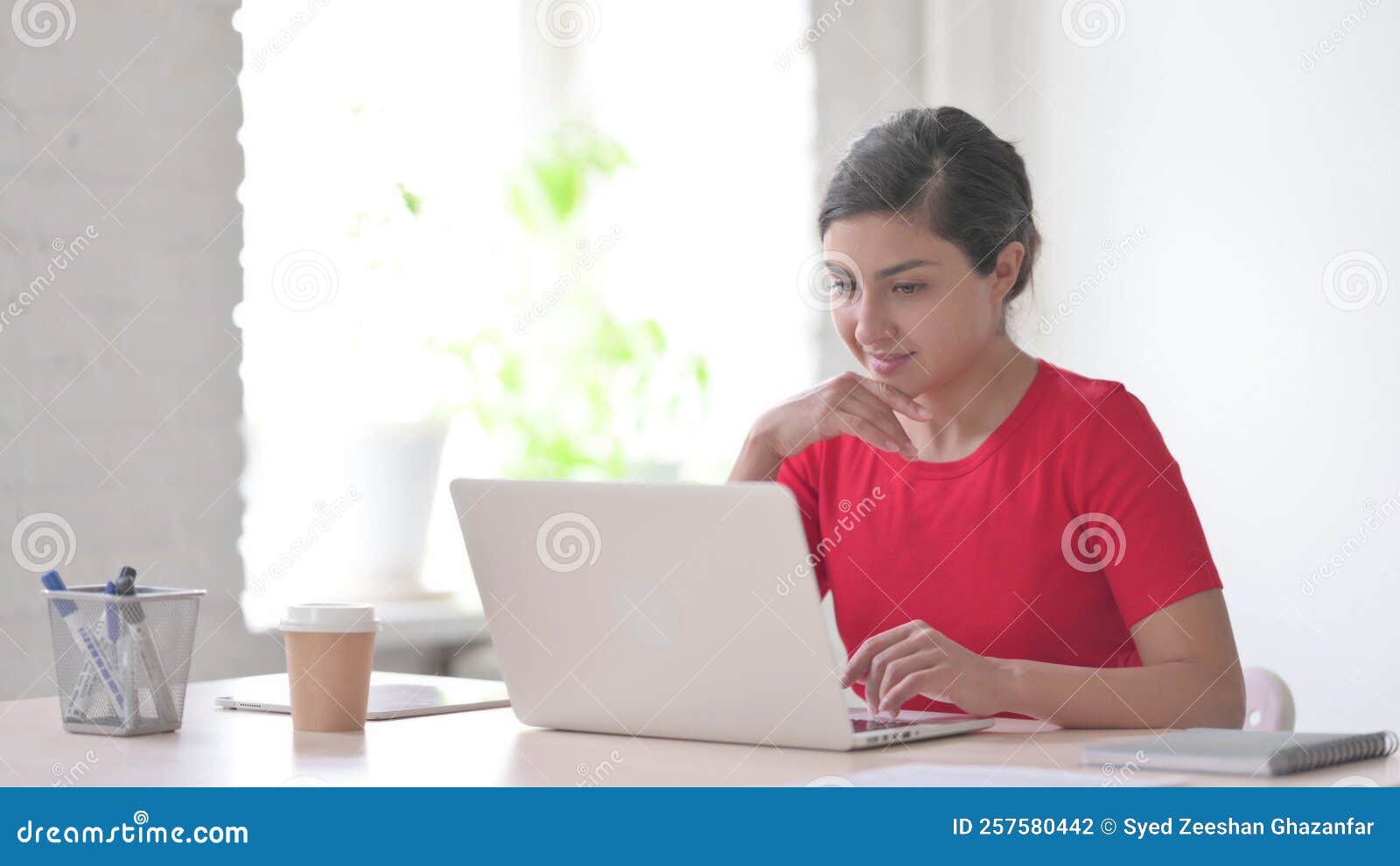 Indian Woman Thinking while Working on Laptop in Office Stock Photo ...