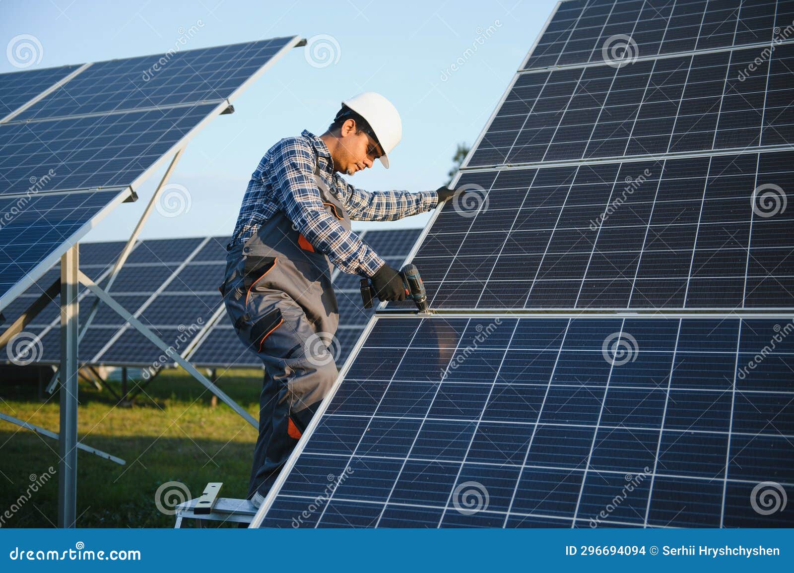 An Indian Worker Installs Solar Panels. the Concept of Renewable Energy ...
