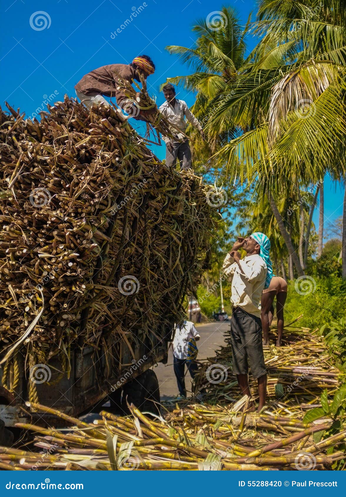Indian Men Workers Unload The Boat With Sand By Manual Labor On The ...