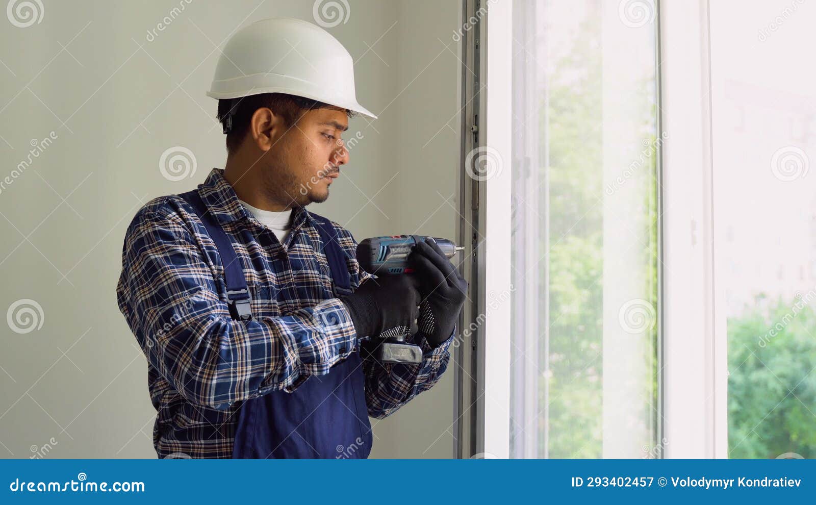 Indian Workman in Uniform Installing or Adjusting Plastic Windows in ...