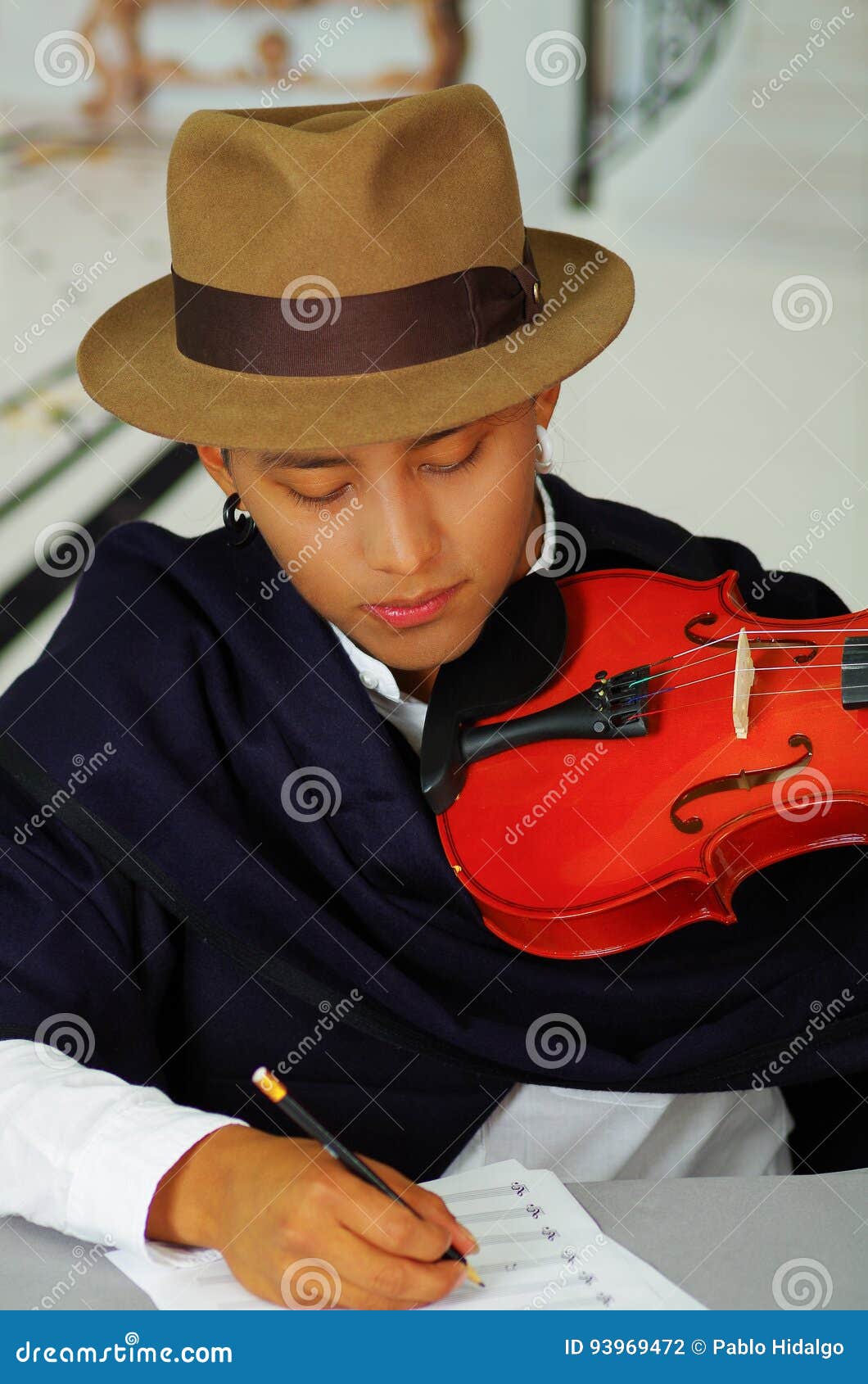 Indigenous Young Man Writing Notes To Music with Violin, Concept of ...