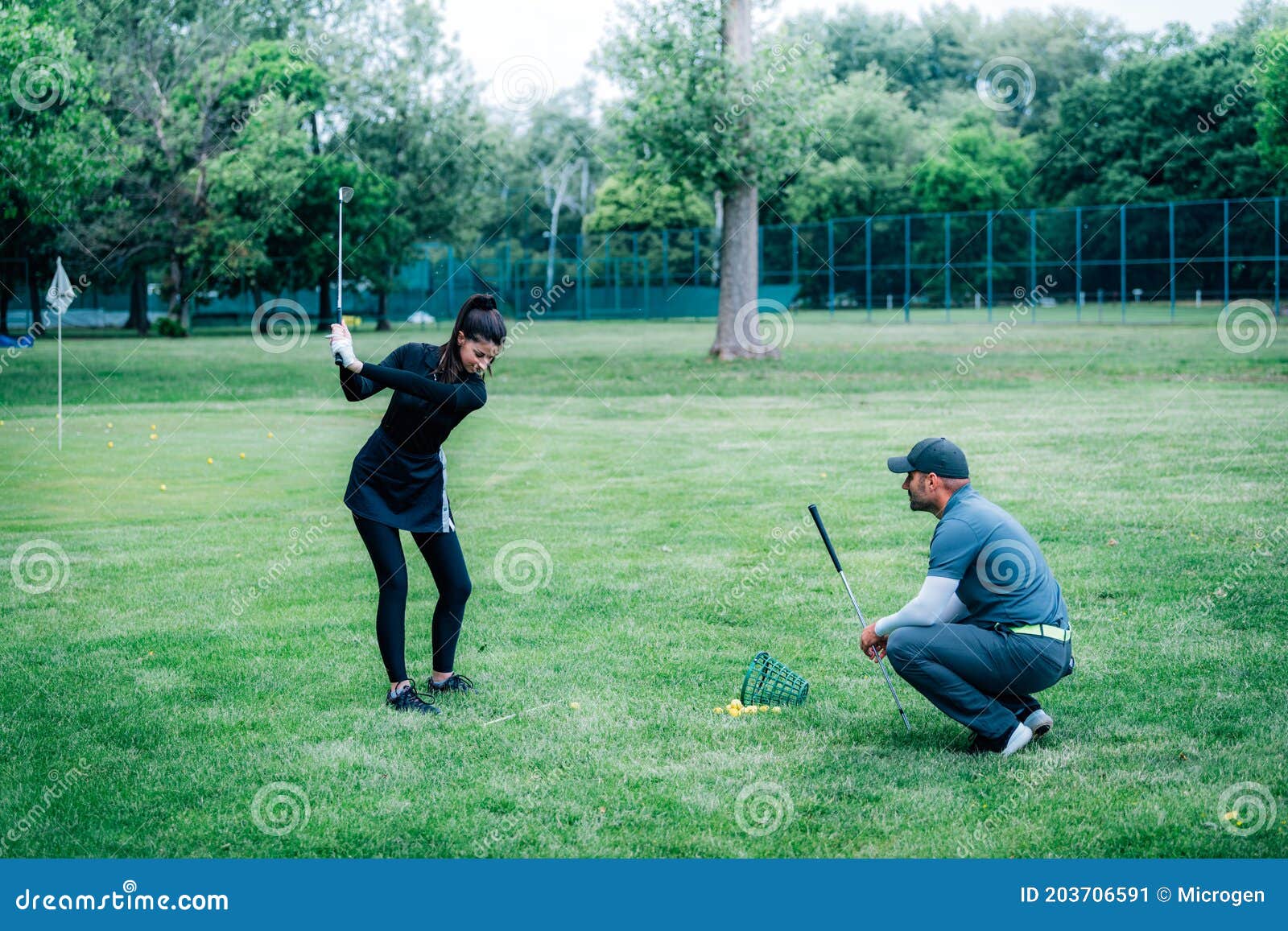 Individual Golf Lesson. Young Woman Having a Golf Lesson with Golf ...
