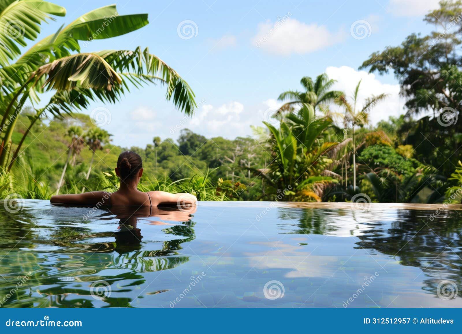 Individual Relaxing in an Infinity Pool Facing a Lush Tropical Garden ...