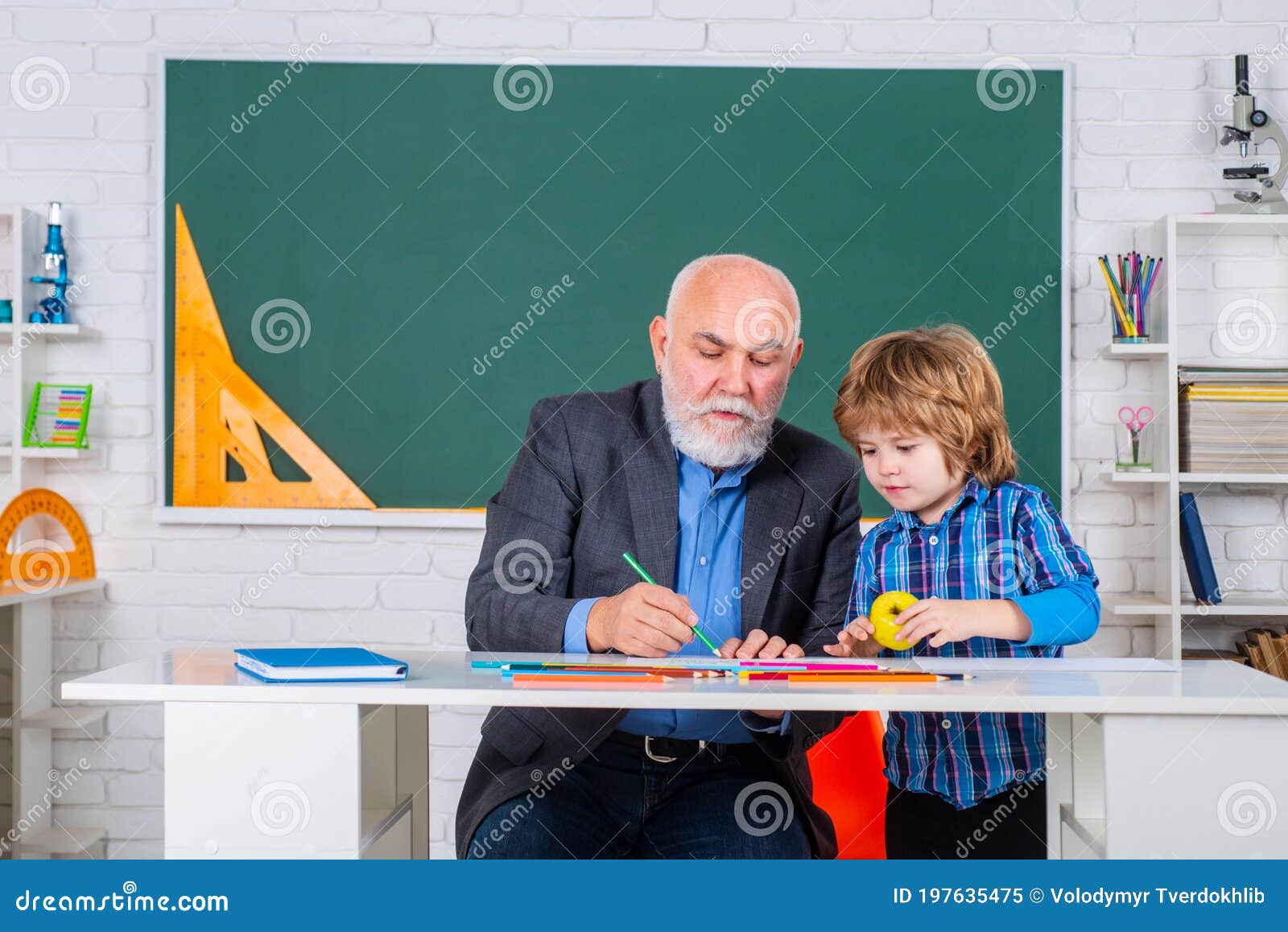 Professor And Pupil In Classroom At The Elementary School. Child At ...
