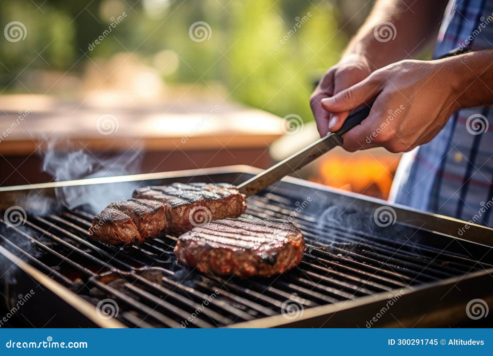 Individual Using a Wide Spatula Flipping a Burger on Grill Outdoors ...