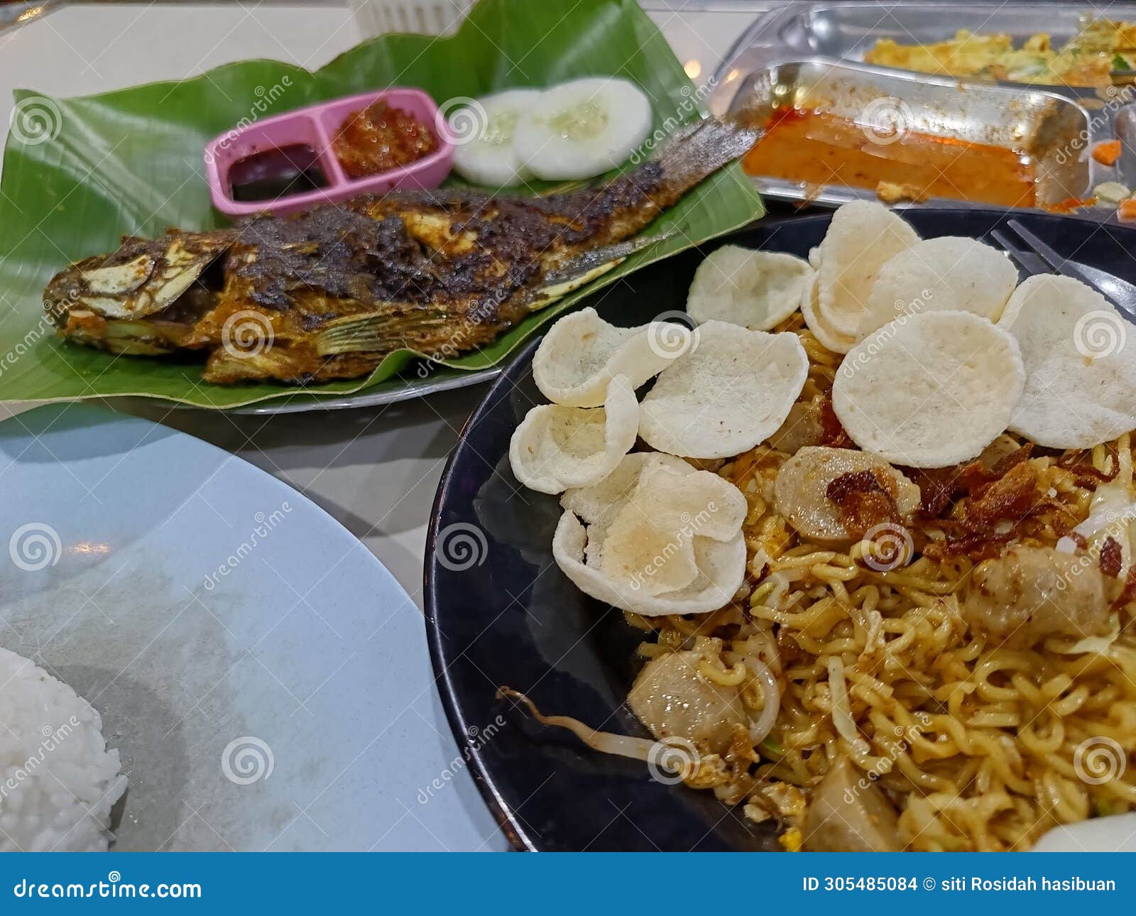 Indonesian Dishes, Fried Noodles and Grilled Fish Stock Photo - Image ...