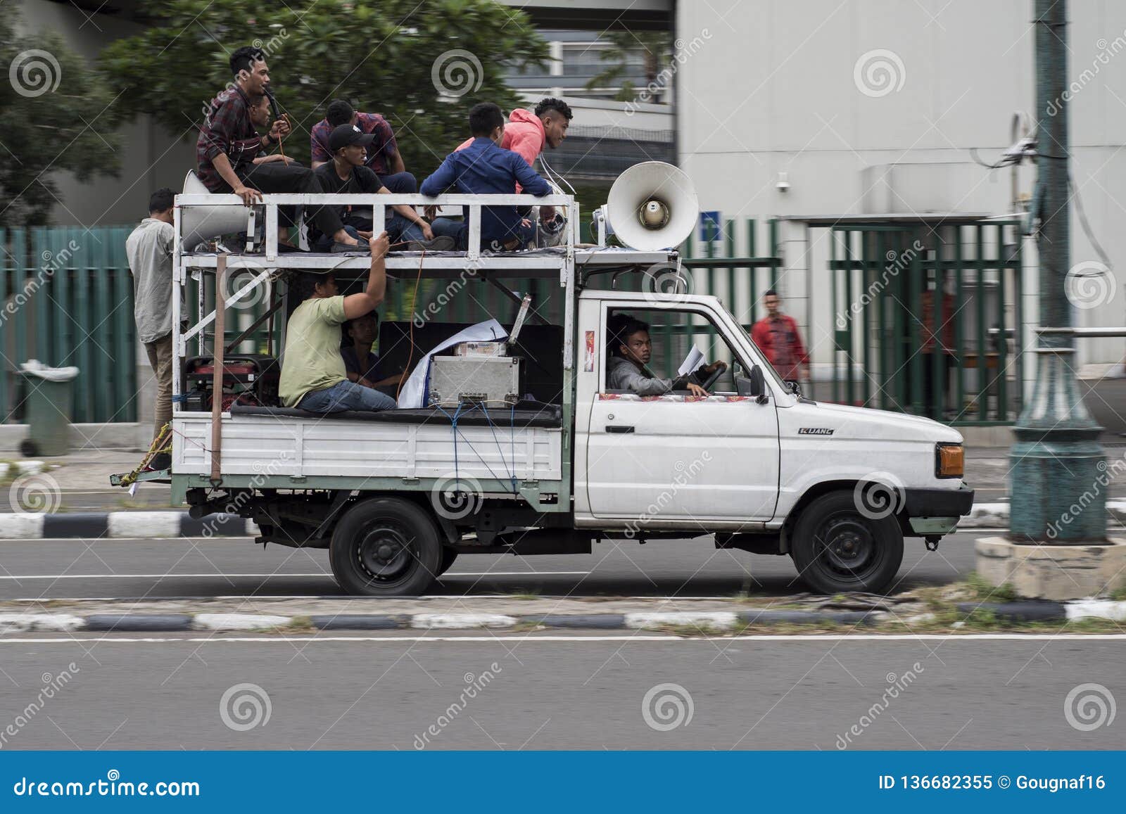 Indonesian Men Pass by in a Pick-up Truck, Blasting Messages in a Loud ... Indonesian Men Pass by in a Pick-up Truck, Blasting Messages in a Loud ...