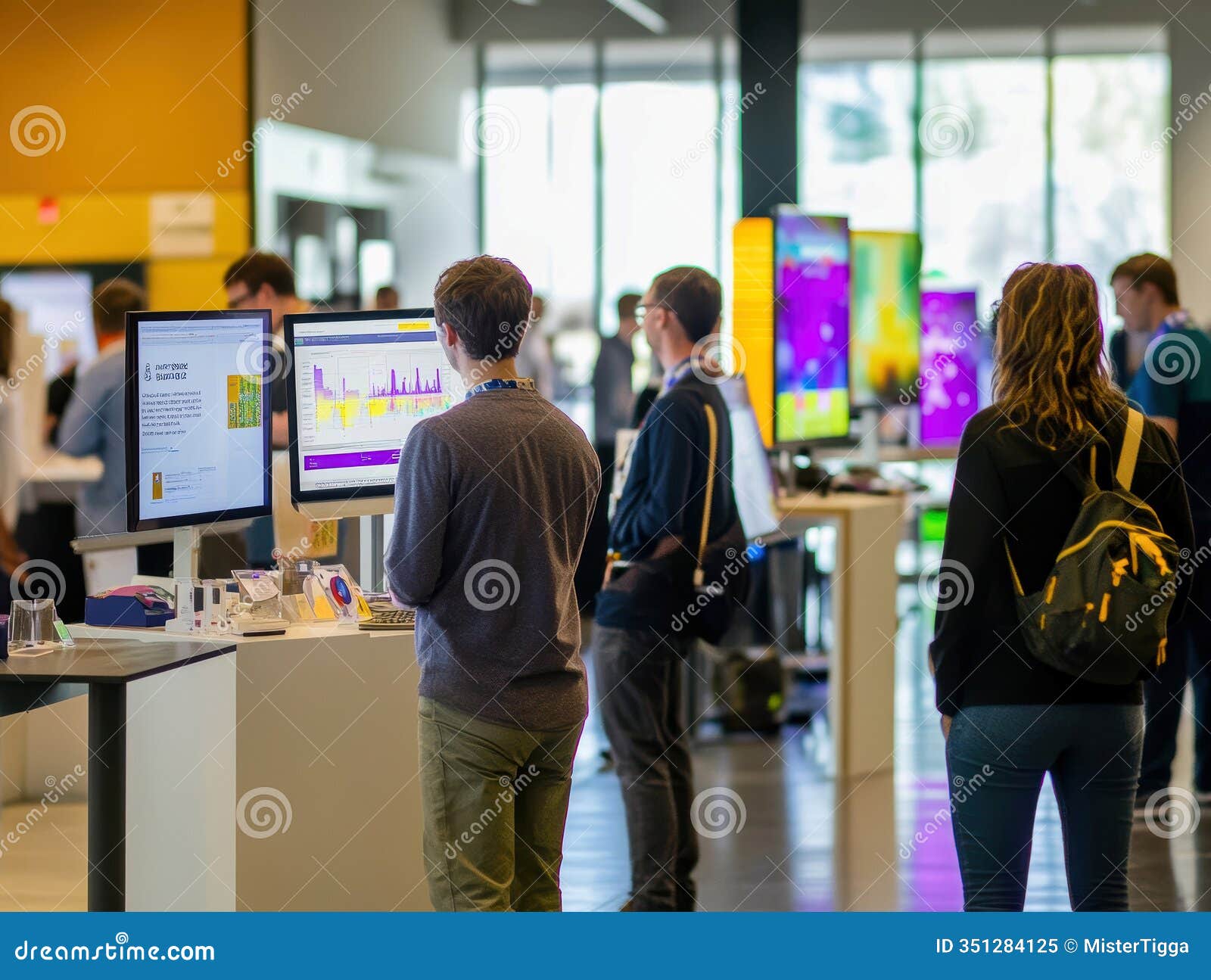 Indoor Tech Event or Exhibition with Multiple Attendees Observing ...