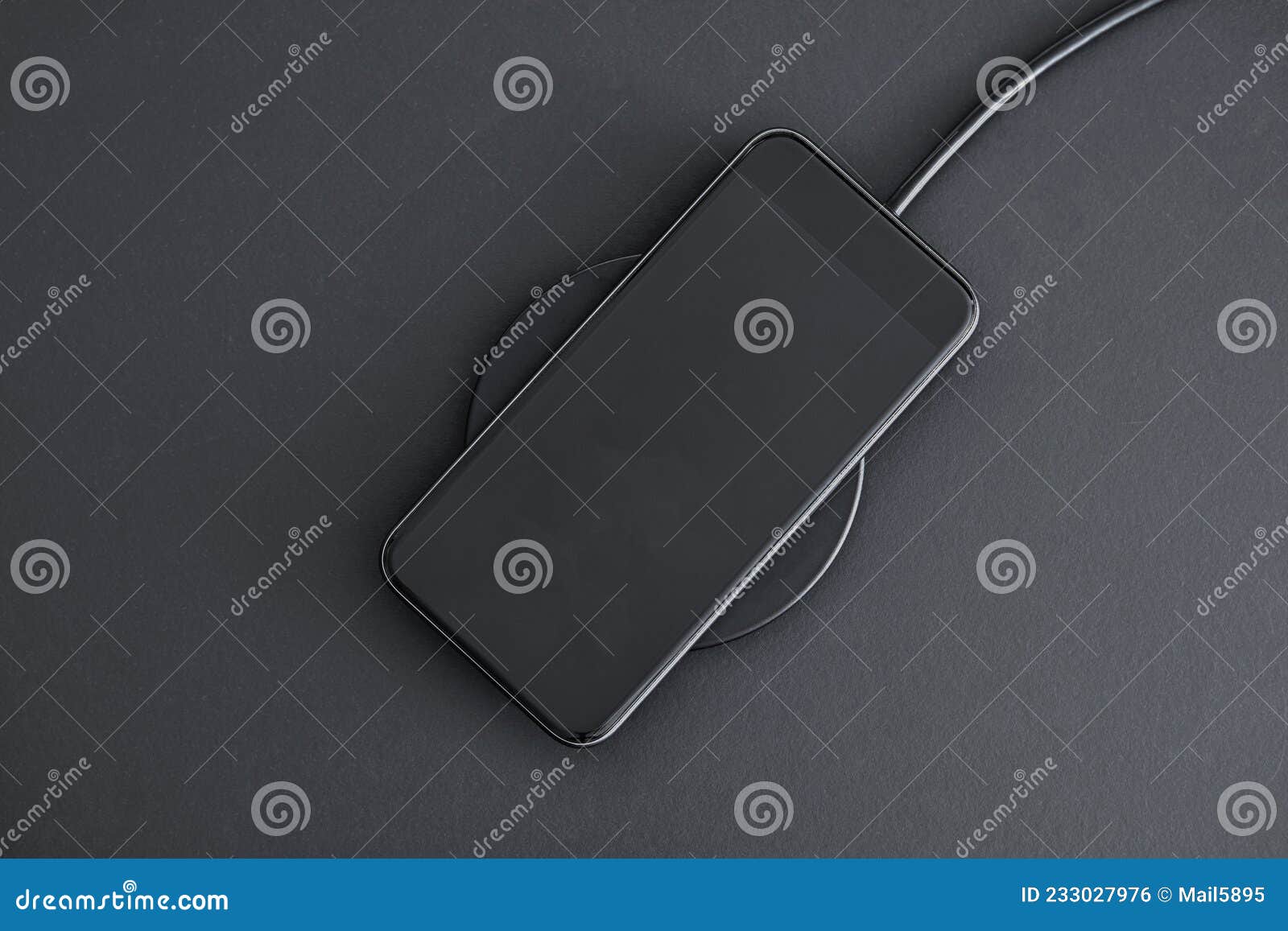 Induction Wireless Charging of Mobile Phone. High Angle View of ...