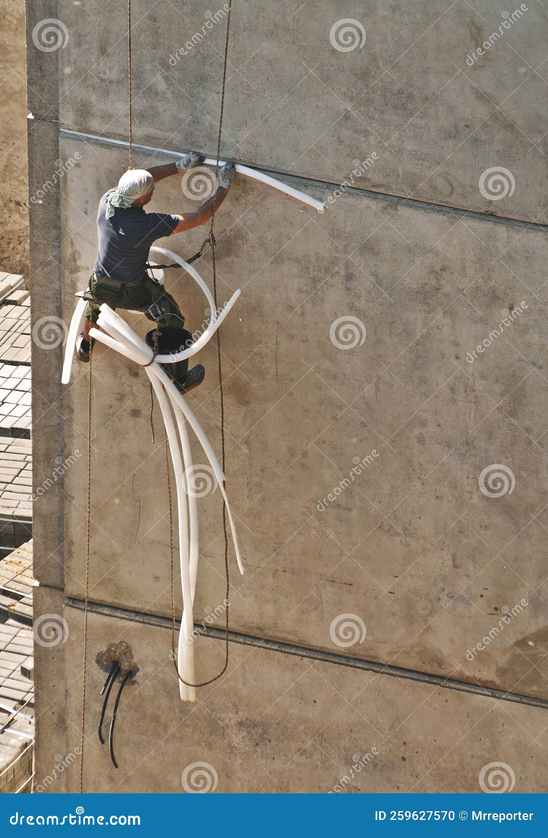 Industrial Alpinist Construction Worker Seals Up Concrete Joints with ...