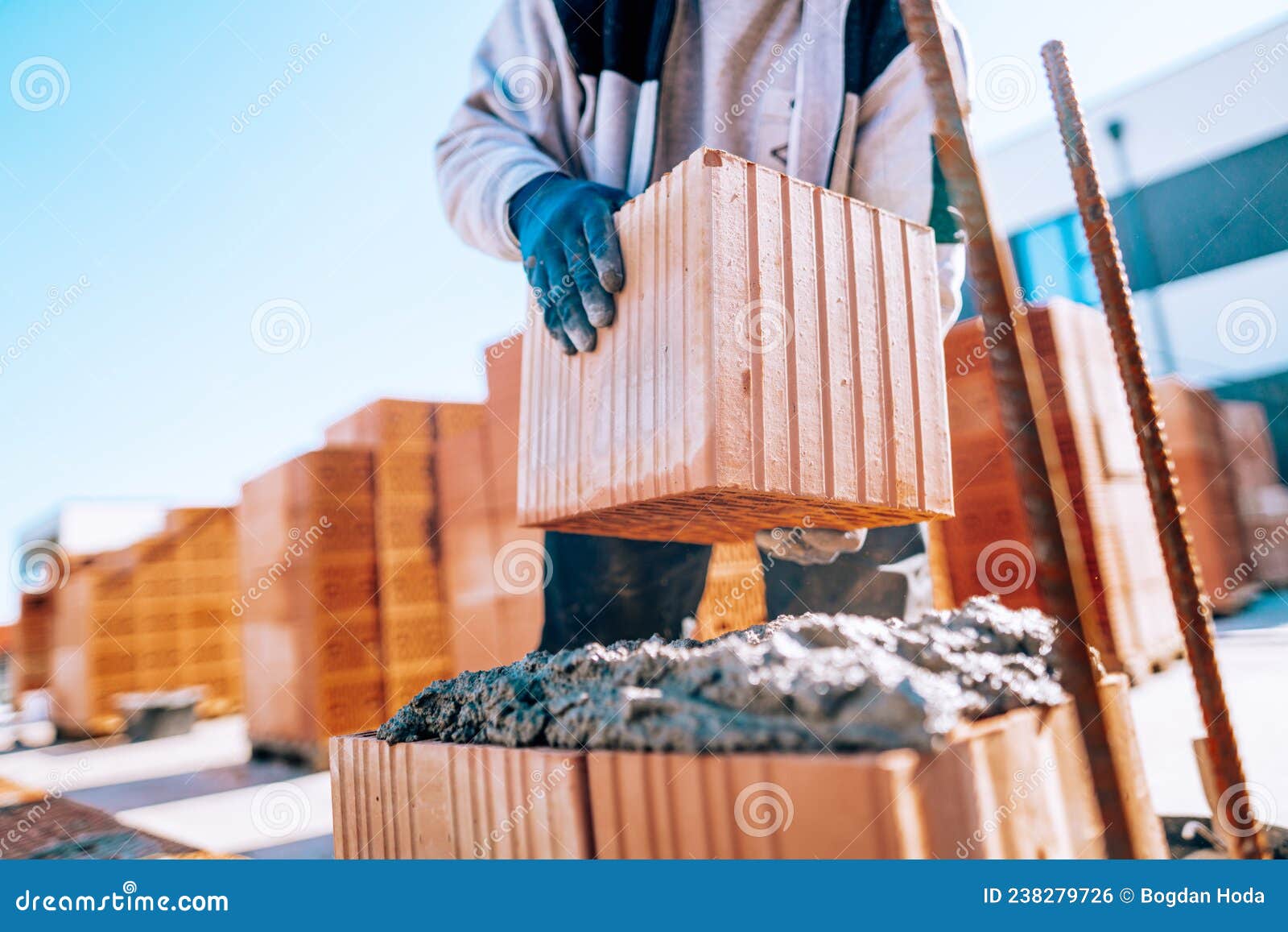Industrial Bricklayer Installing Bricks on Construction Site Stock ...