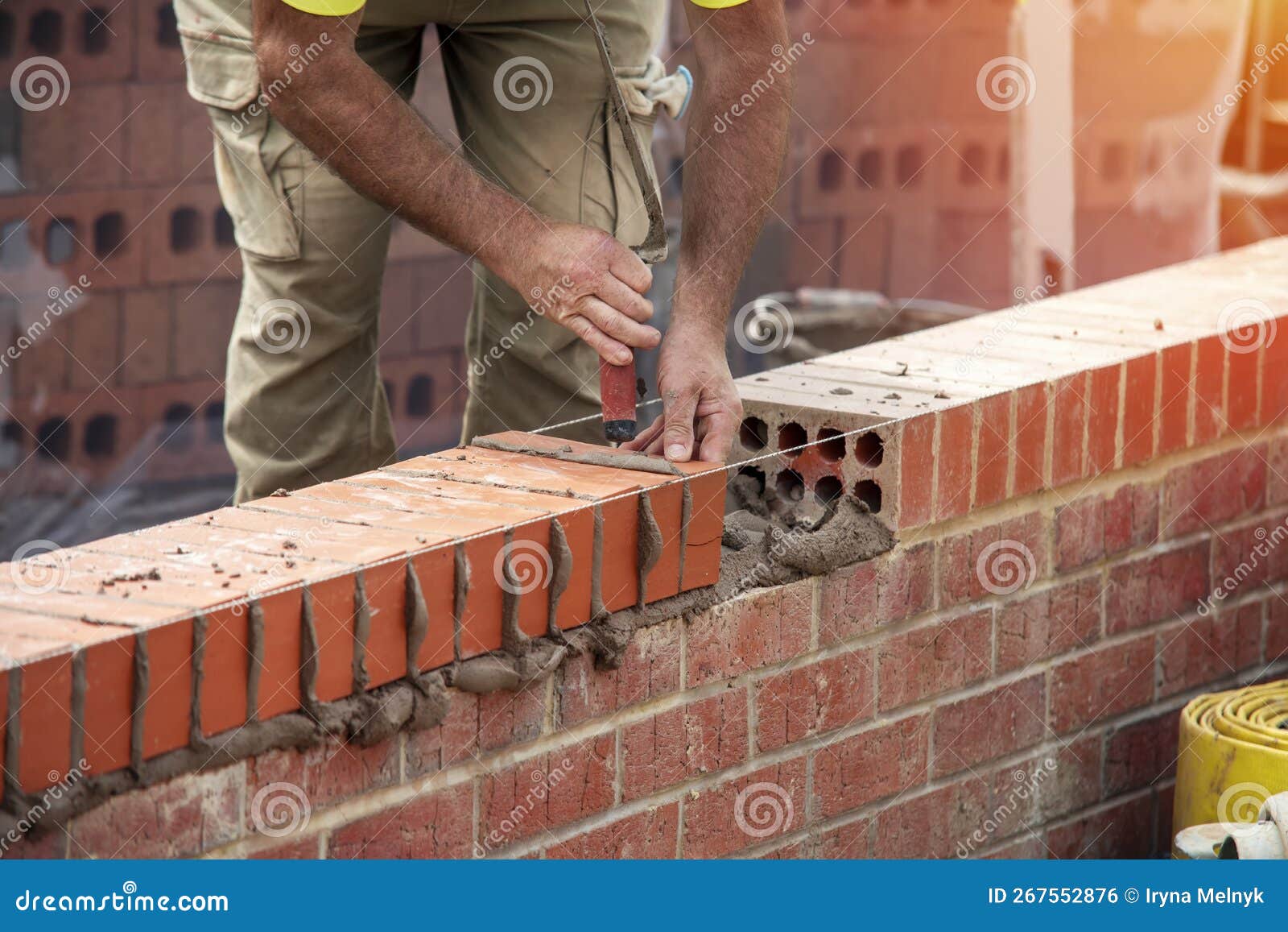 Industrial Bricklayer Laying Bricks on Cement Mix on Construction Site ...
